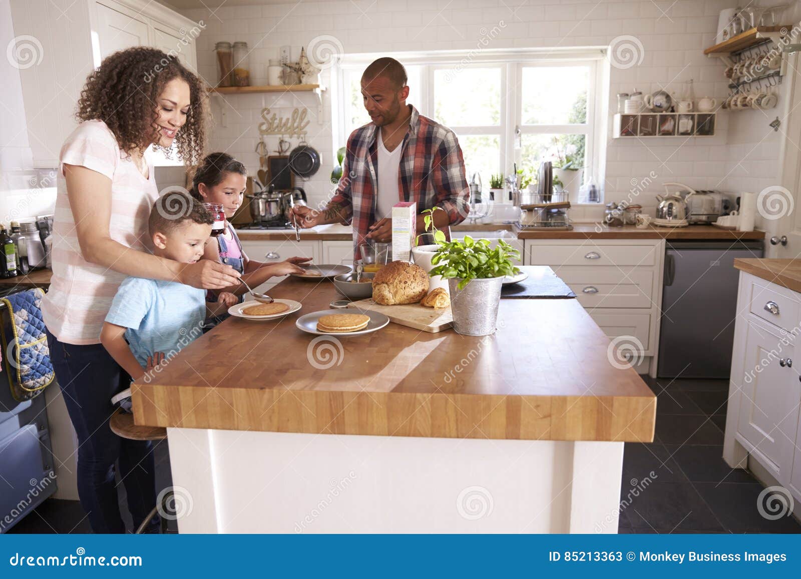 Family at Home Eating Breakfast in Kitchen Together Stock Image - Image ...