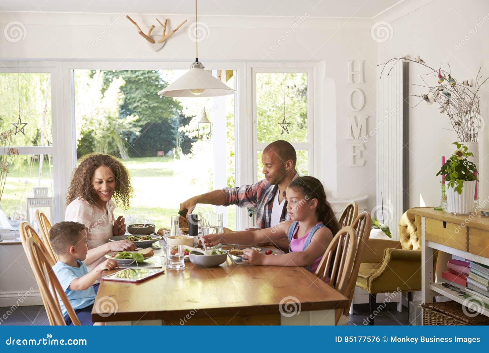 Family at Home Eating Meal in Kitchen Together Stock Photo - Image of ...