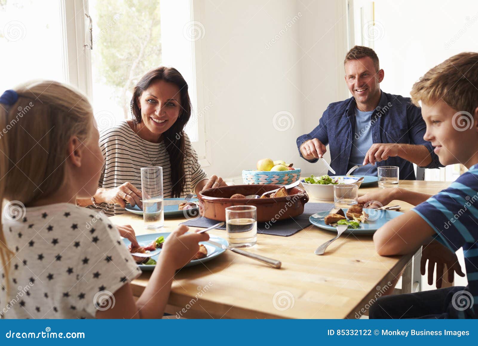 Family at Home in Eating Meal Together Stock Photo - Image of family ...