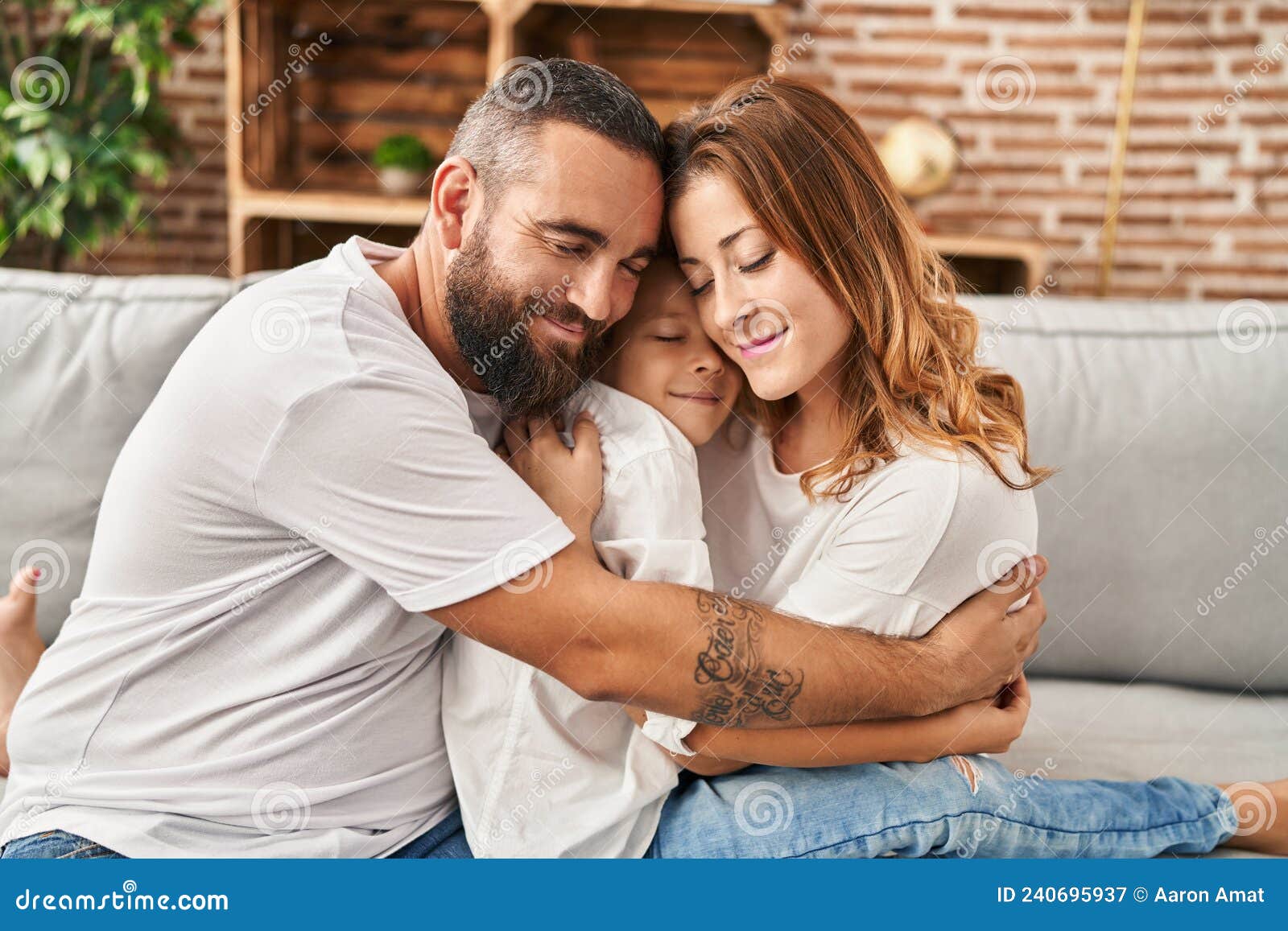 Family Hugging Each Other Sitting on Sofa at Home Stock Image - Image ...