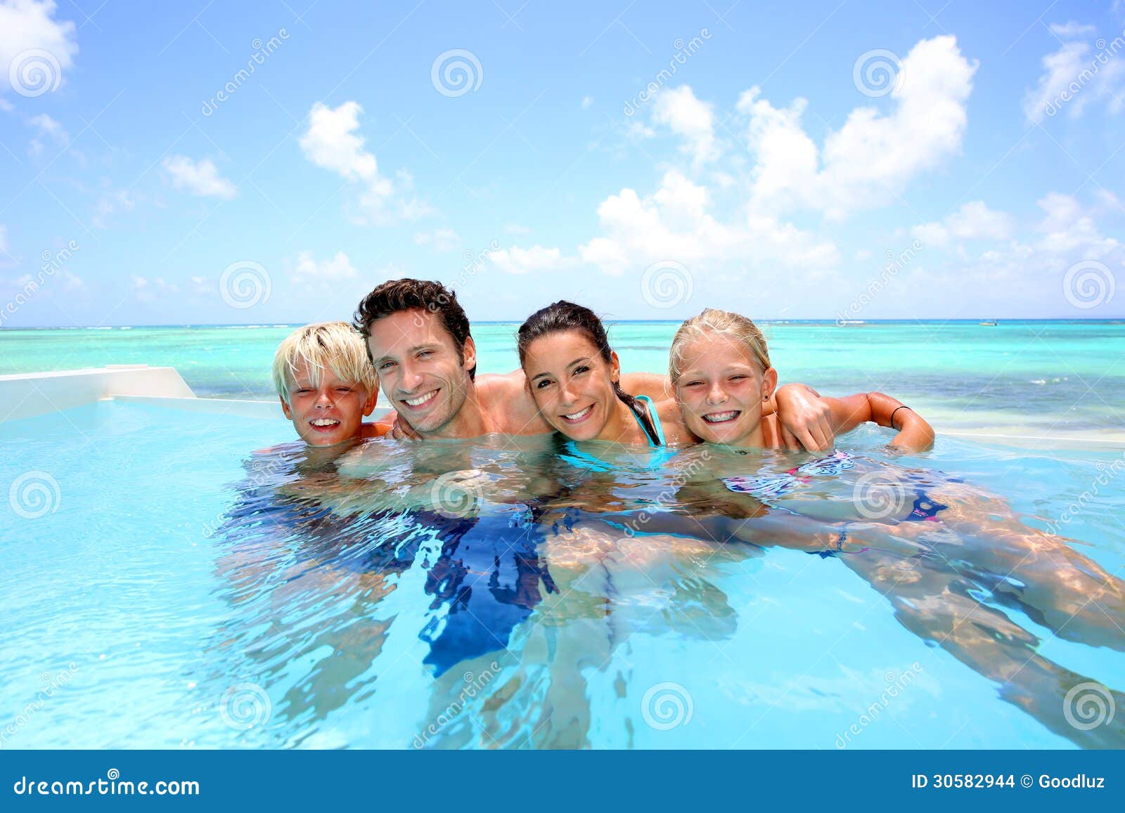 Family in infinity pool stock photo. Image of couple - 30582944