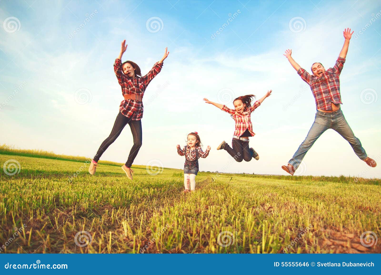 Family Jumping in the Field Stock Photo - Image of together, family ...
