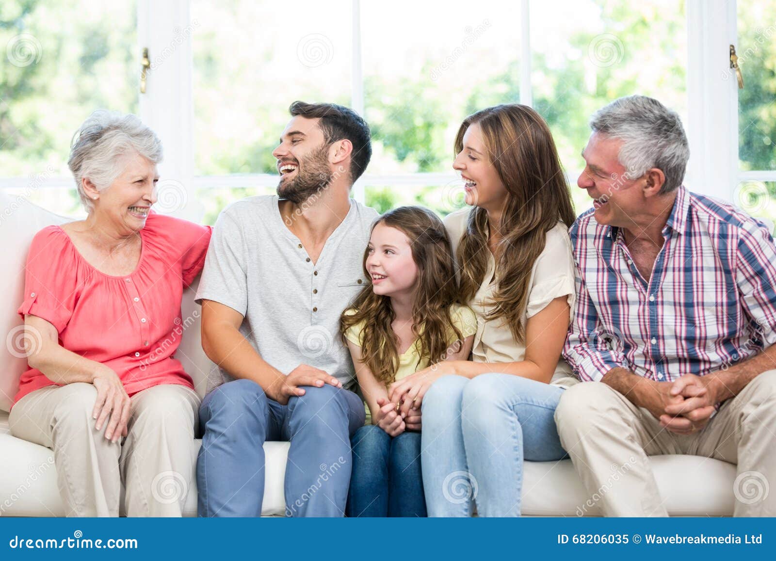 Family Laughing while Sitting on Sofa Stock Image - Image of ...