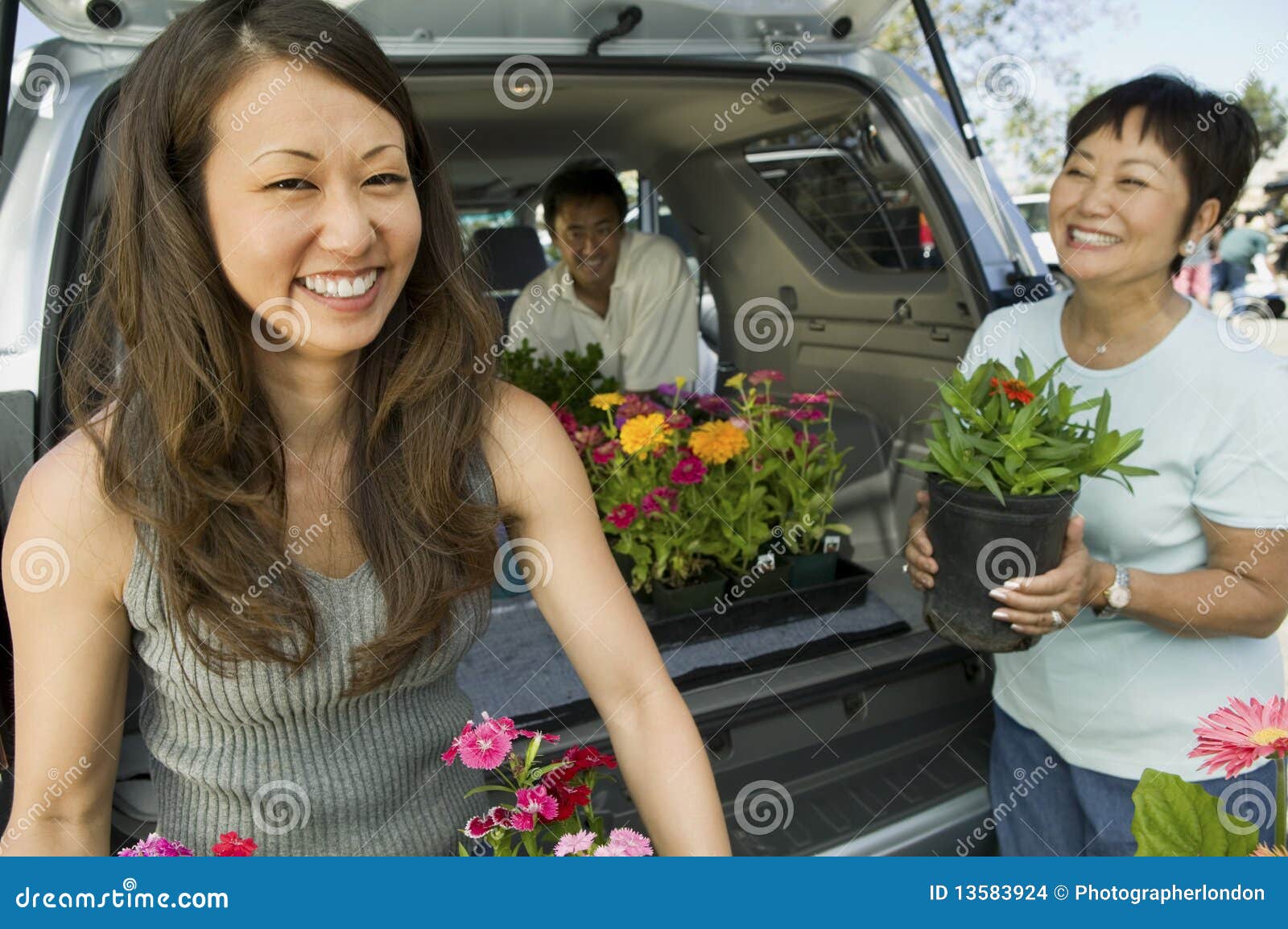 Family Loading Flowers into SUV Stock Photo - Image of motor, outside ...