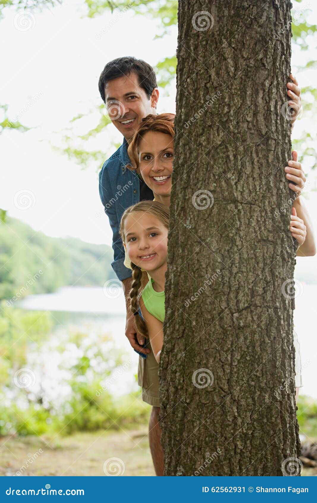 Family Looking Around a Tree Stock Image - Image of enjoyment ...