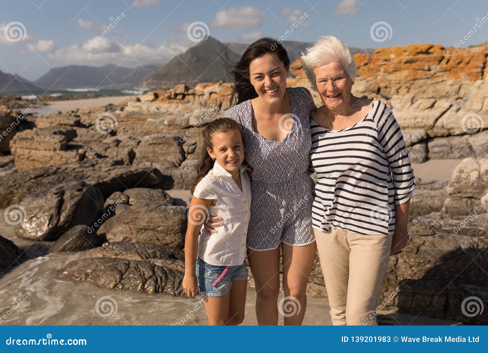 Family Looking at Camera on Beach Stock Image - Image of childhood ...