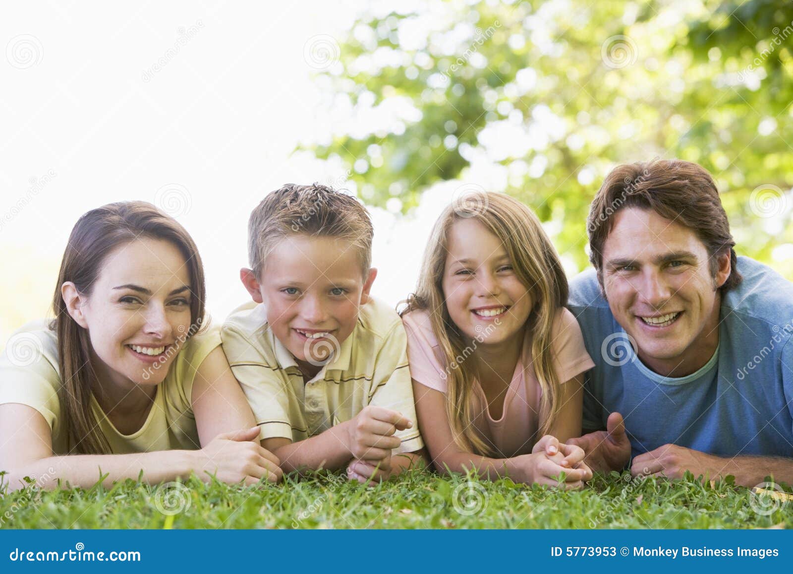 Family Lying Outdoors Smiling Stock Image - Image of male, enjoying ...