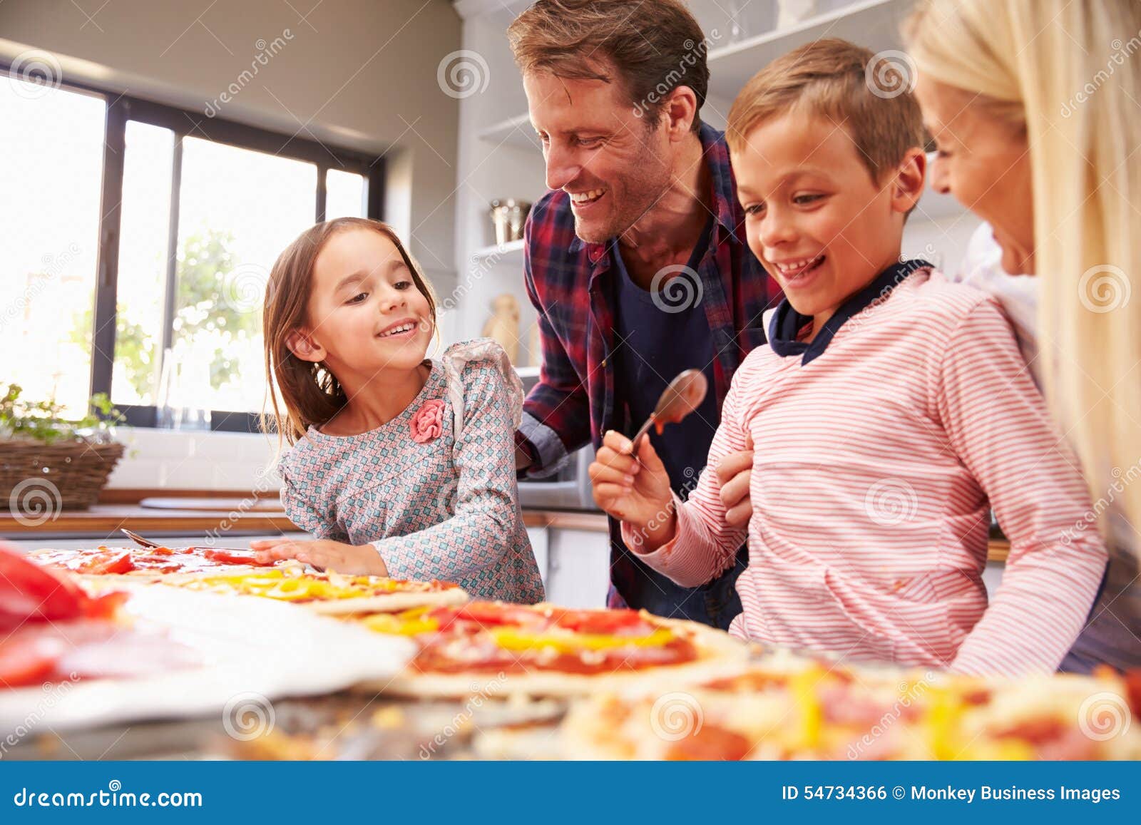 Family Making Pizza Together Stock Photo - Image of cooperation ...