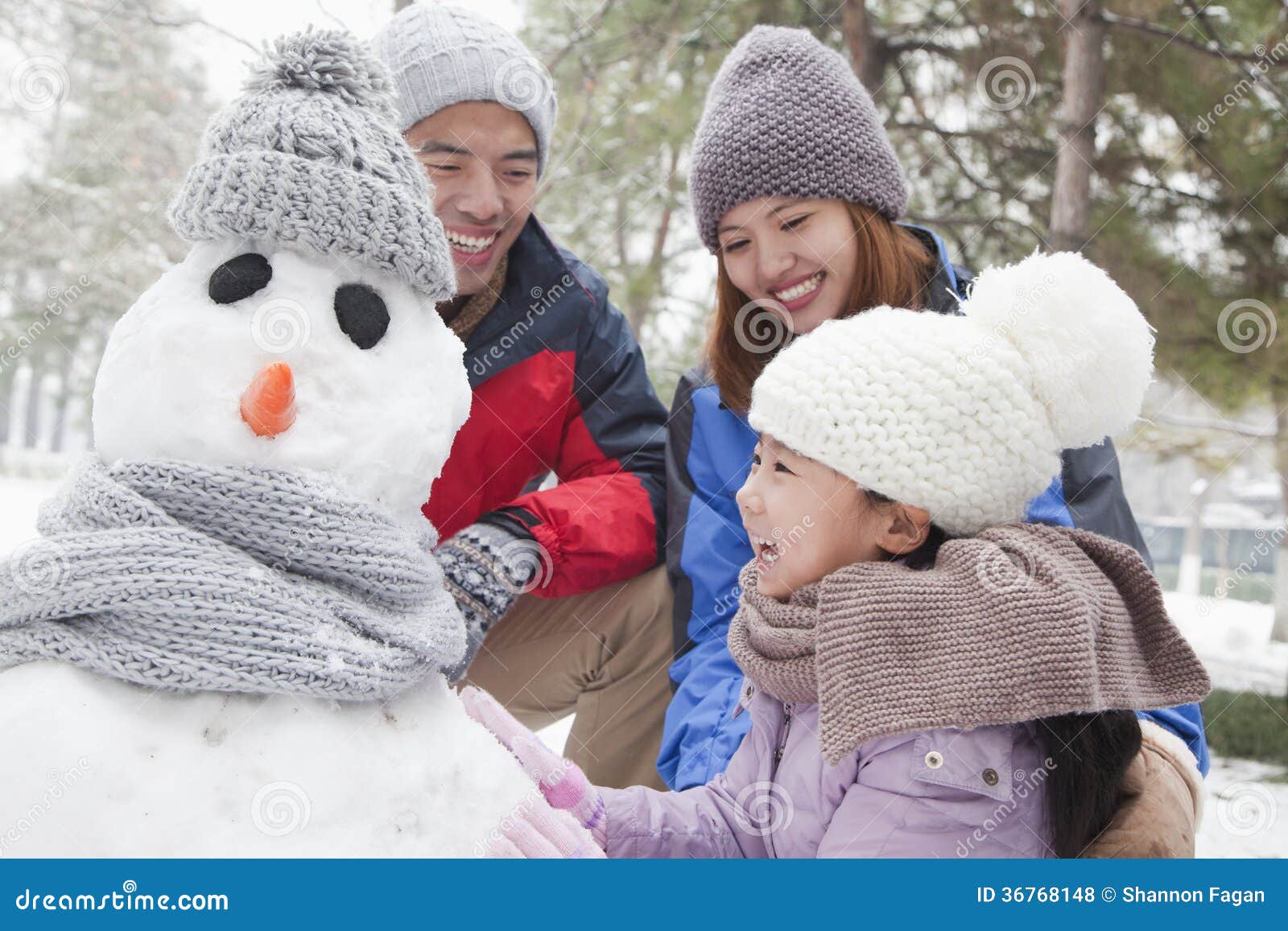 Family Making Snowman in a Park in Winter Stock Photo - Image of child ...