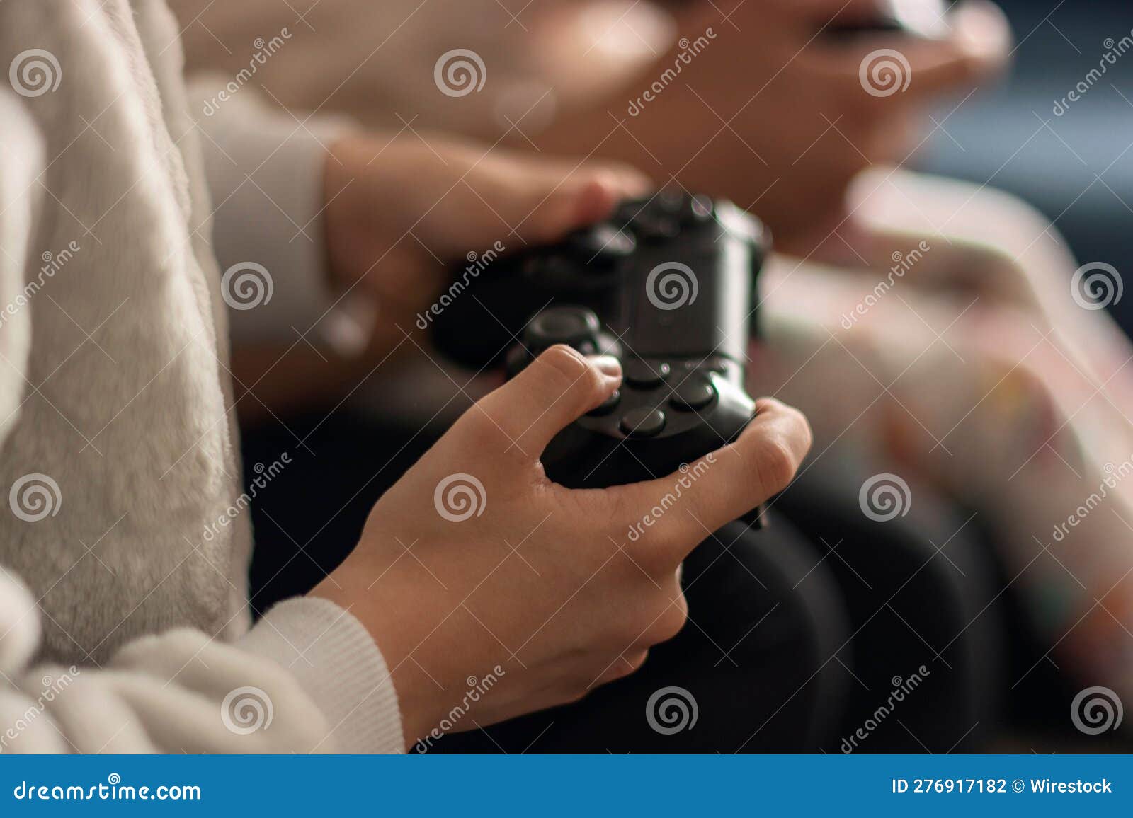 Family Members Holding Game Controllers in Their Hands Stock Photo ...