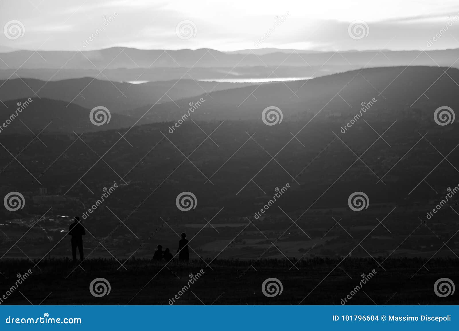 Family on a Mountain Peak Looking Over a Valley at Sunset Stock Photo ...