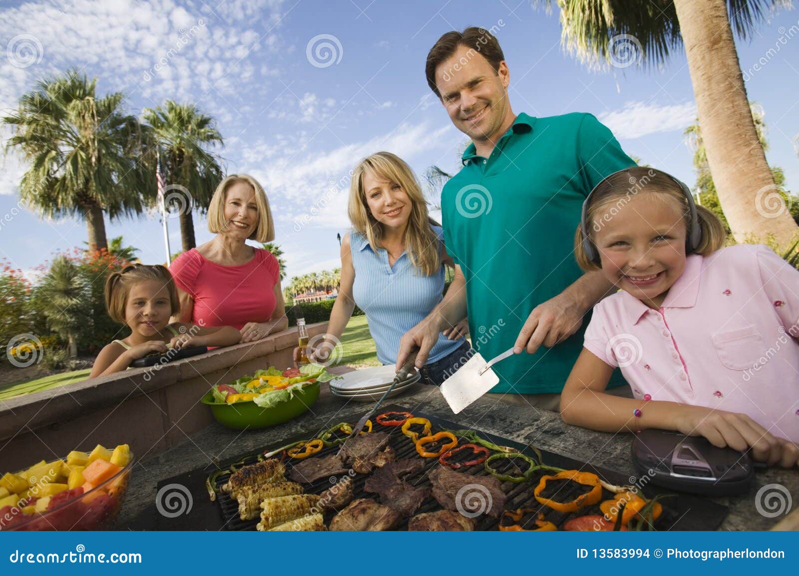 Family at outdoor barbecue stock photo. Image of standing - 13583994