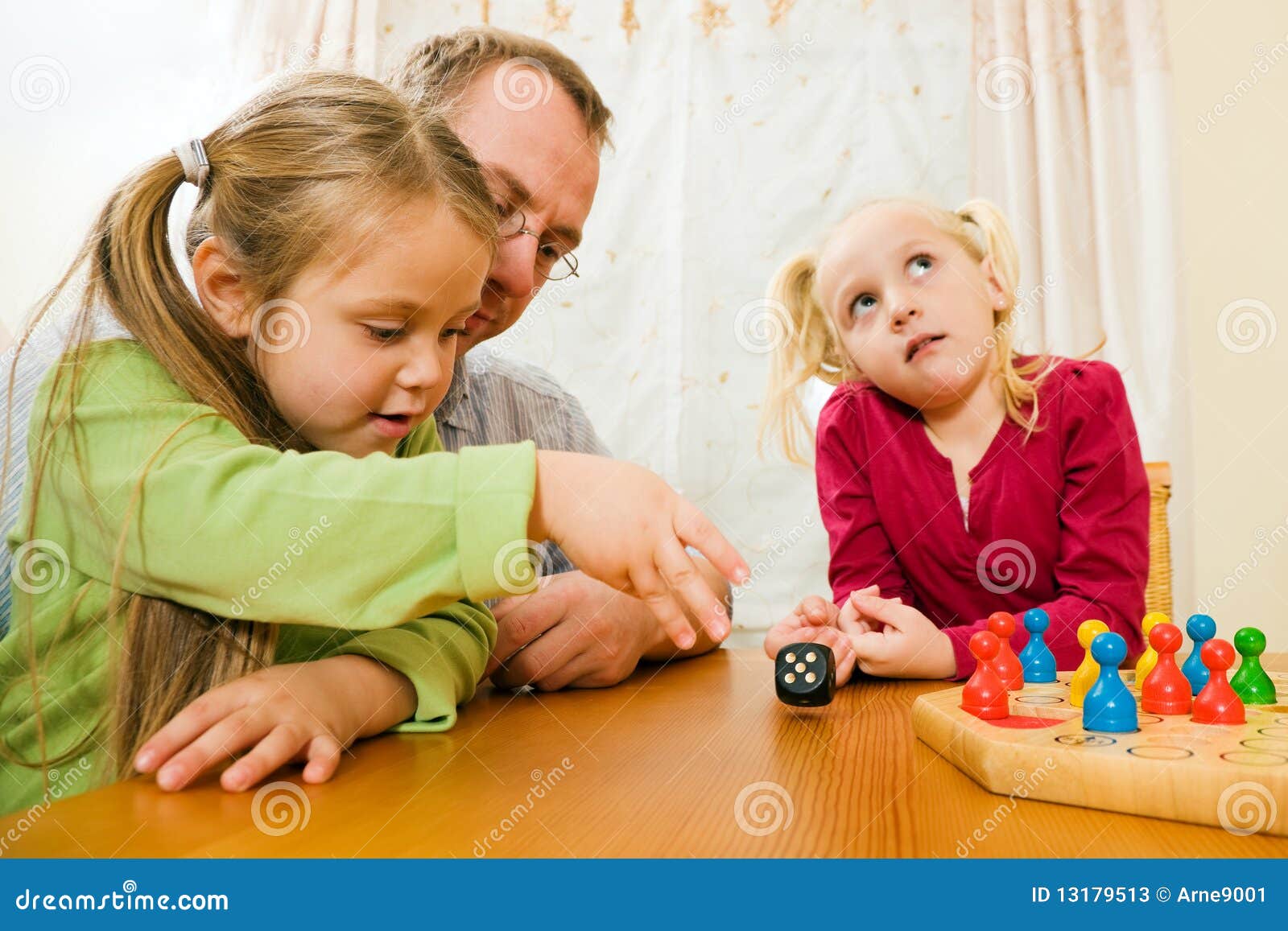 Family Playing a Board Game Together Stock Image - Image of family ...