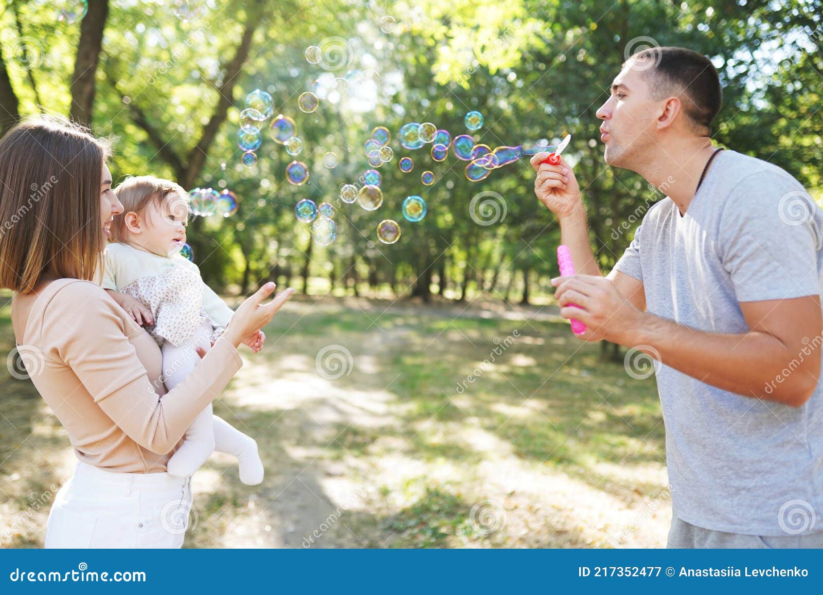 Family Playing with Bubbles Outdoors in the Park Stock Image - Image of ...