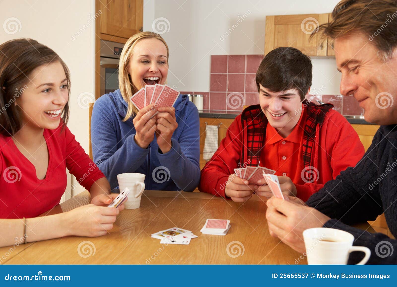 Family Playing Cards in Kitchen Stock Image - Image of mother, middle ...