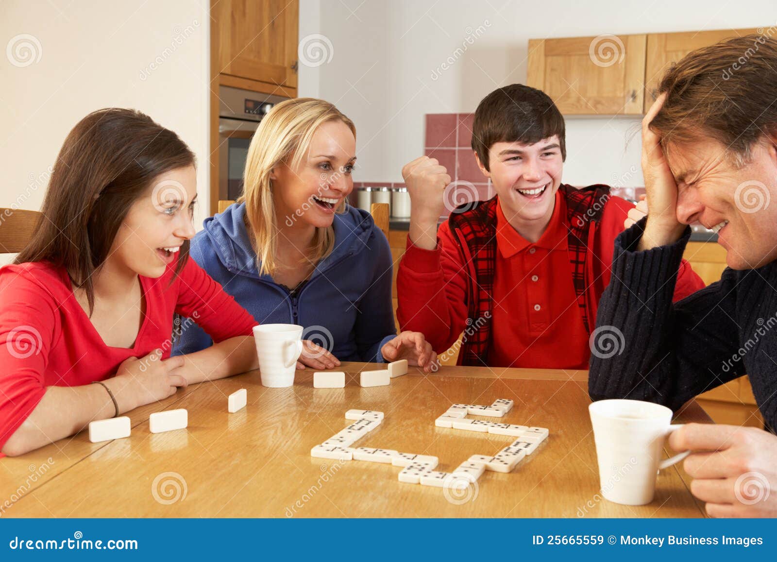 Family Playing Dominoes in Kitchen Stock Image - Image of parents, male ...