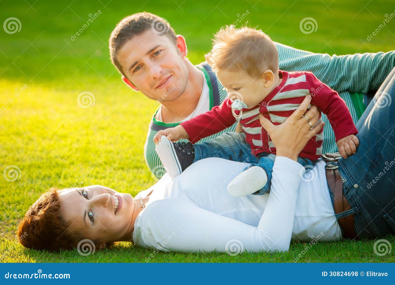 Family playing on grass stock photo. Image of infants - 30824698