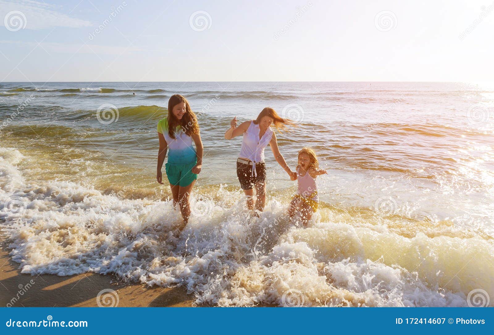Family Playing on the Ocean Shore Stock Image - Image of outdoor ...