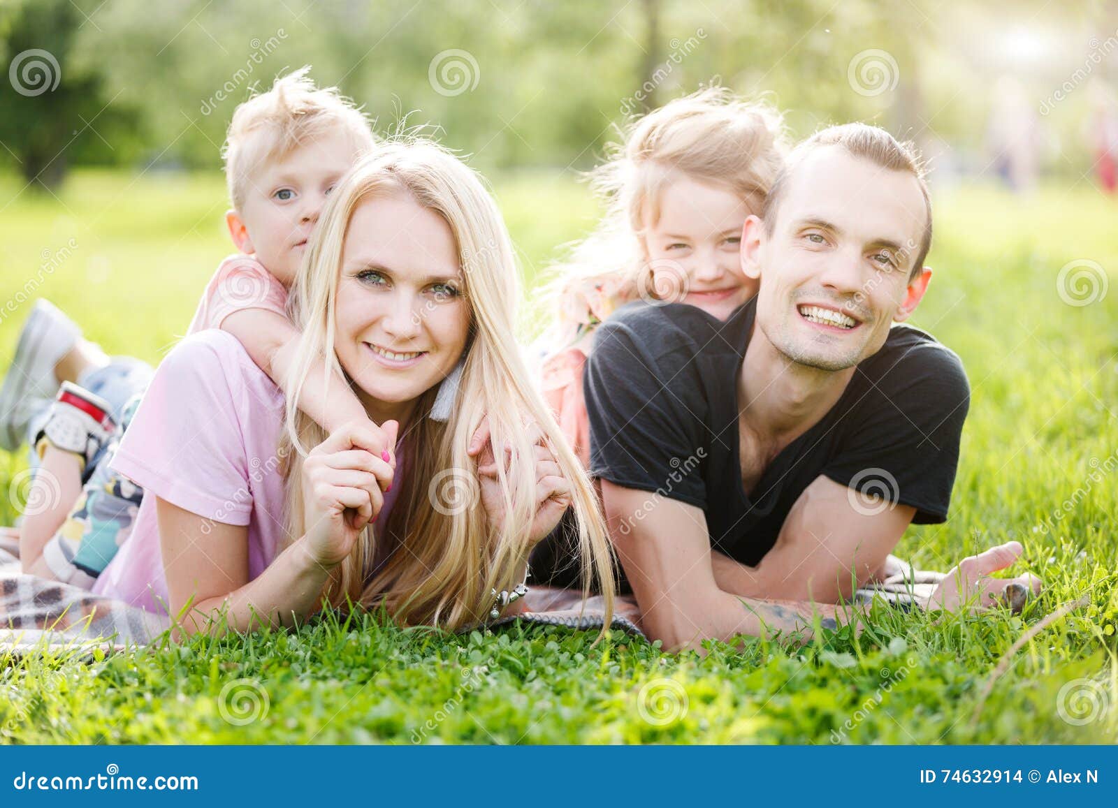 Family Playing in the Park on the Grass Stock Photo - Image of adult ...