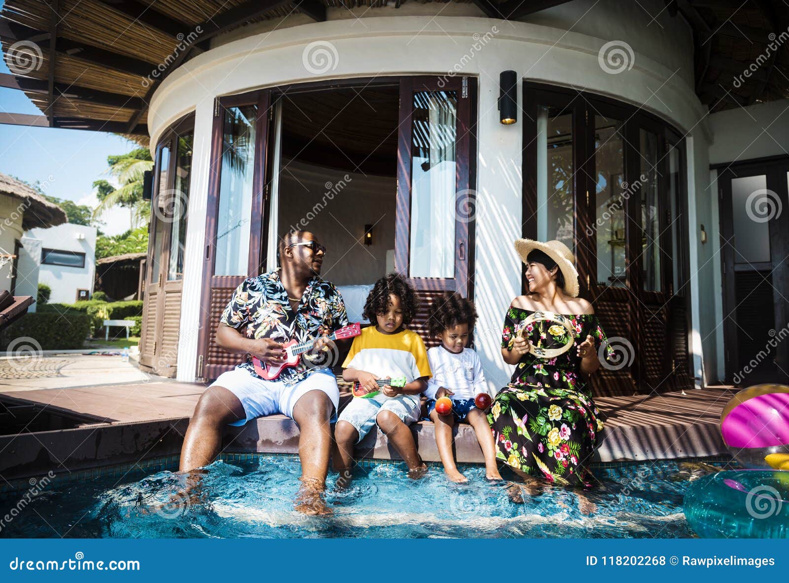 Family playing in a pool stock photo. Image of hotel - 118202268