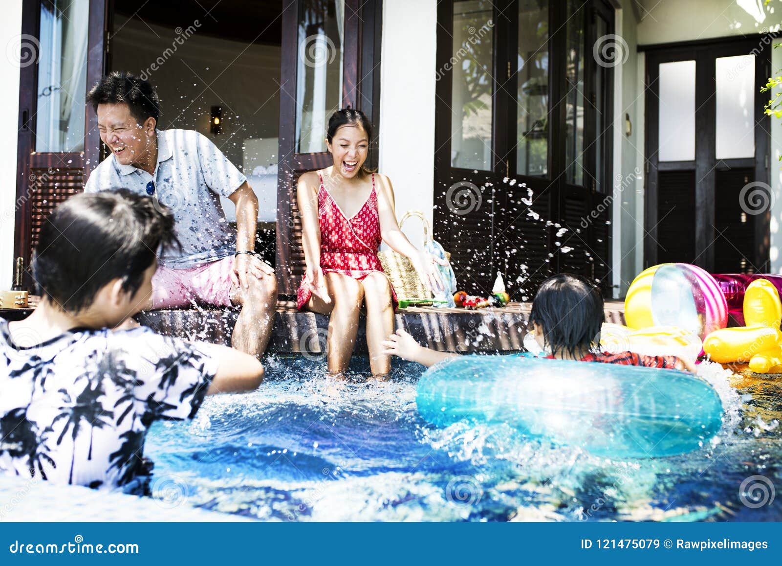 Family playing in a pool stock image. Image of asian - 121475079