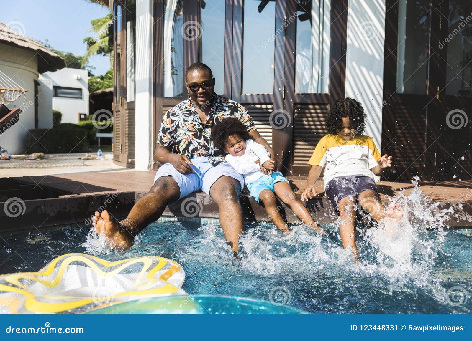 Family playing by a pool stock image. Image of black - 123448331