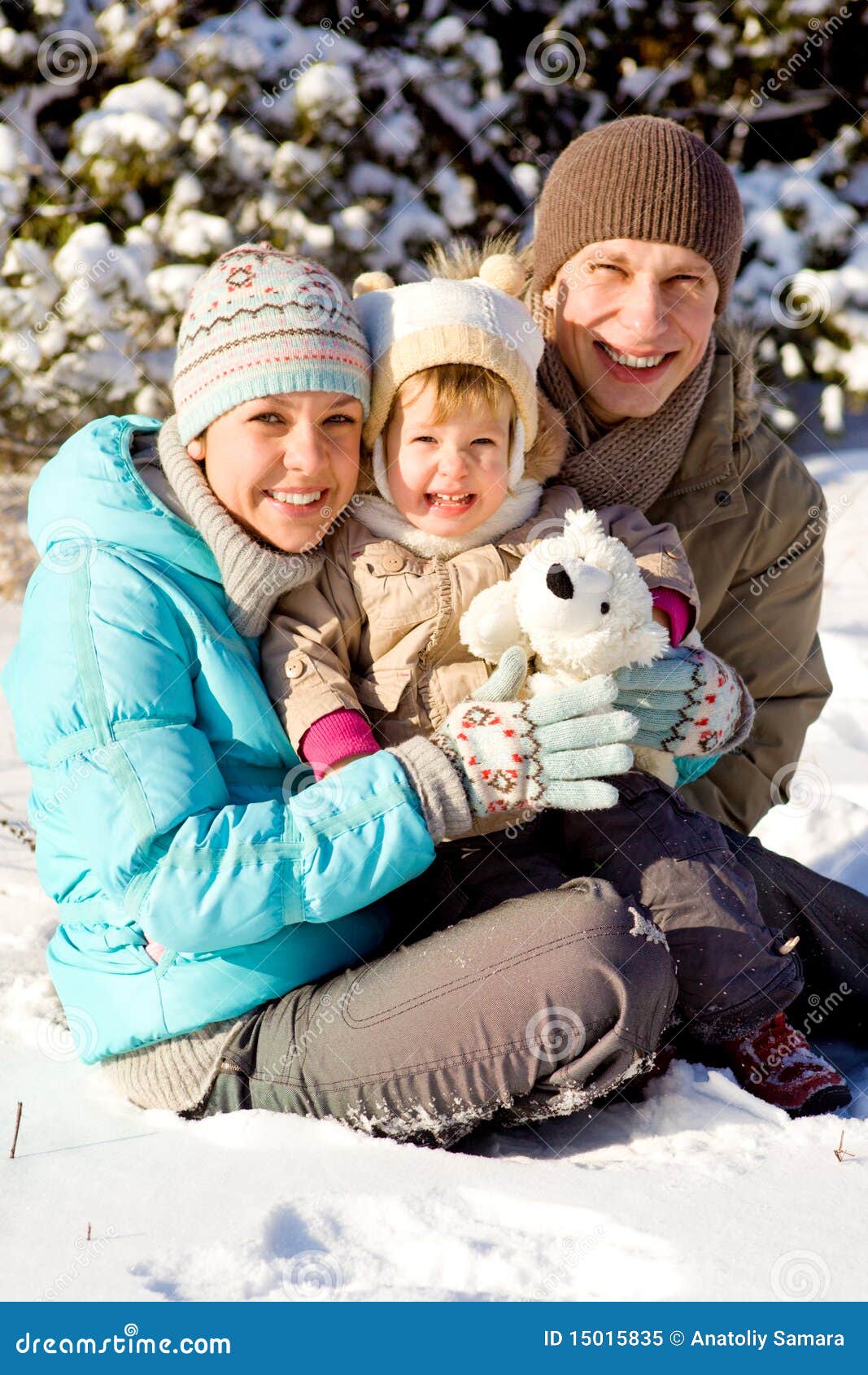 Family playing in snow stock image. Image of embracing - 15015835