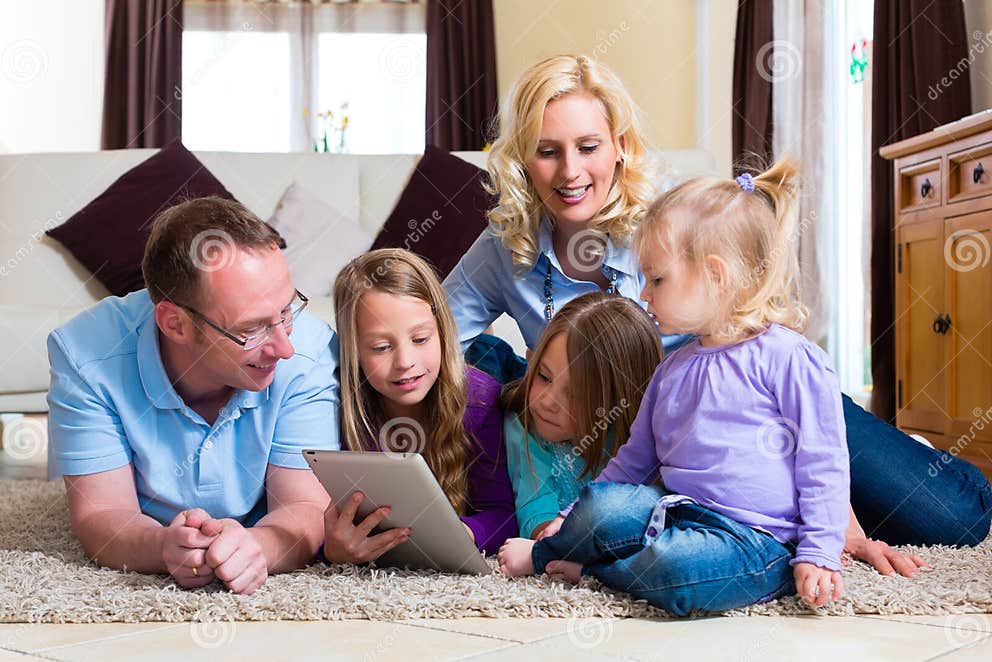 Family Playing with Tablet Computer at Home Stock Photo - Image of ...