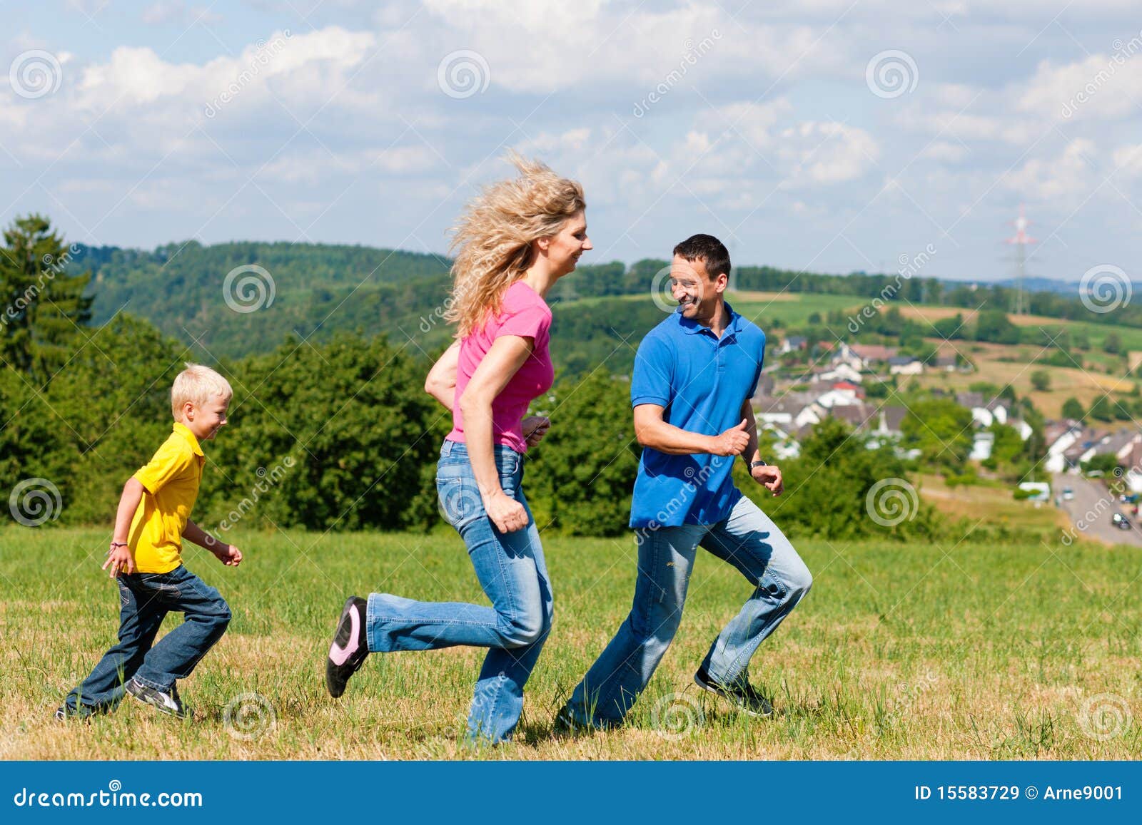 Family Playing Tag on Meadow in Summer Stock Image - Image of smiling ...