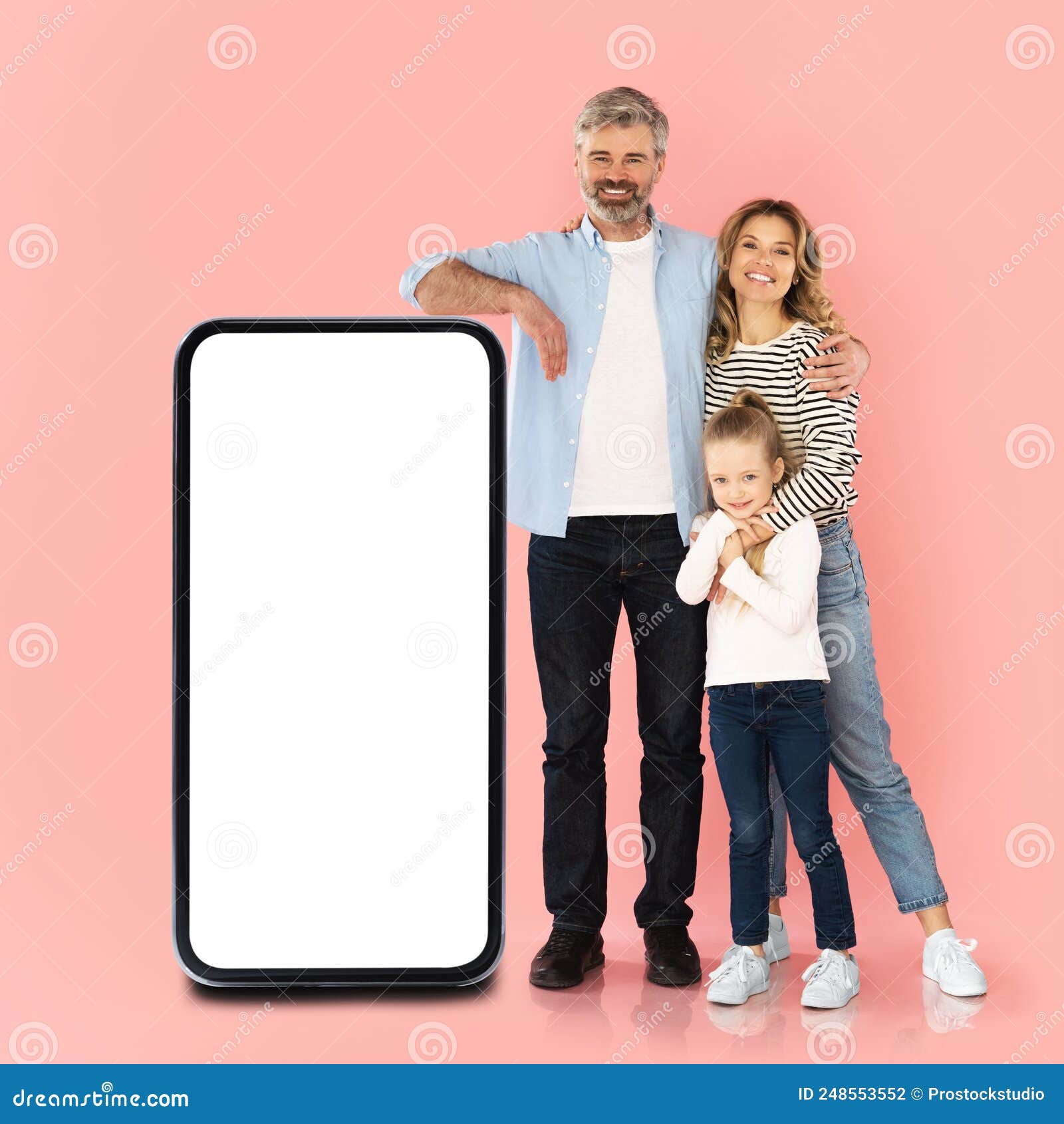Family Posing with Huge Smartphone with Empty Screen in Studio Stock ...