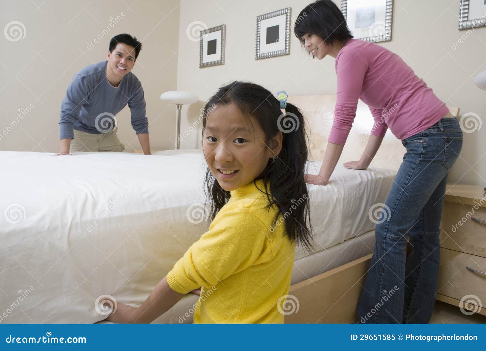Family Preparing Bed Together Stock Image - Image of chinese, bedsheet ...