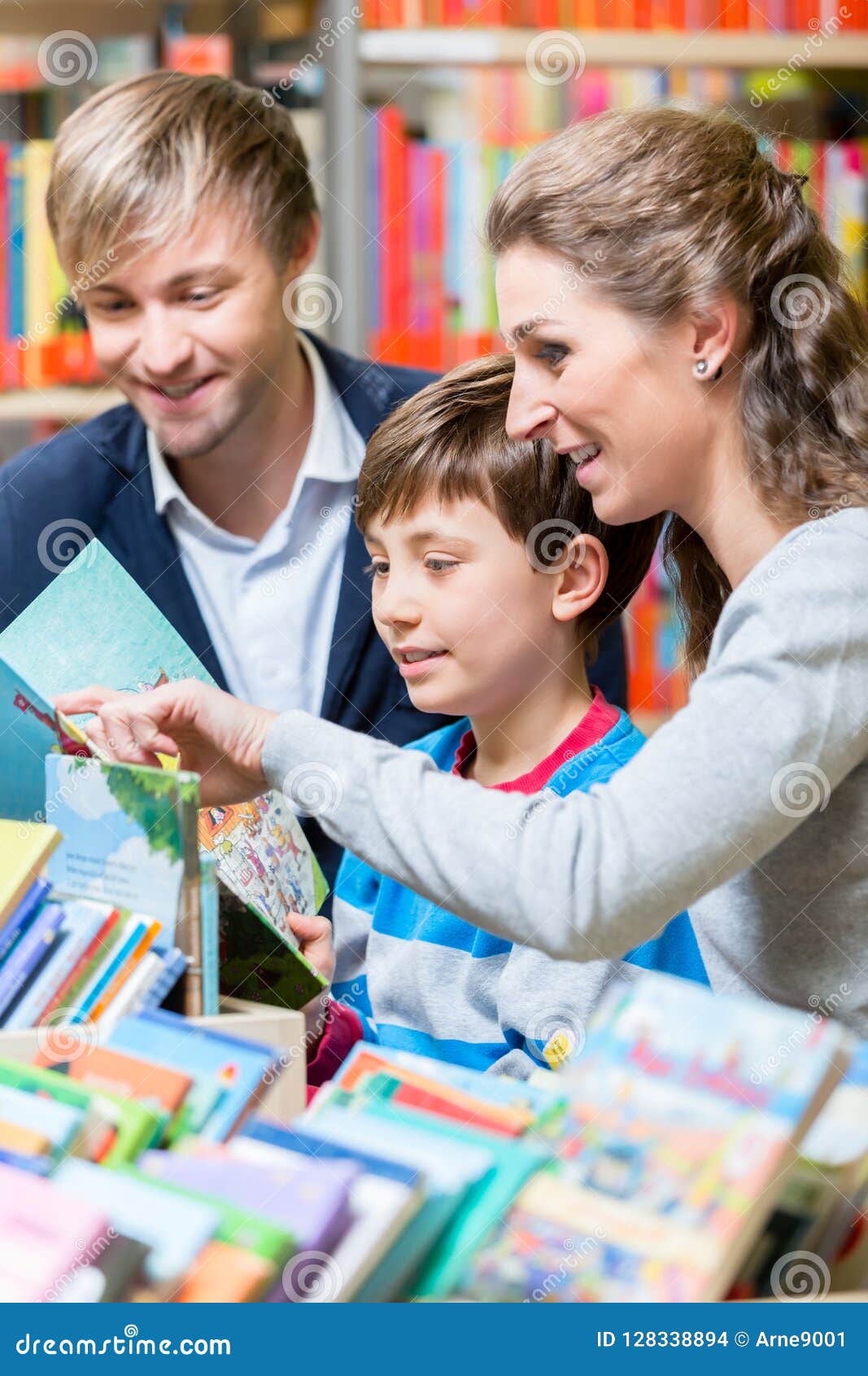 Family Reading a Book in the Library Stock Photo - Image of book, child ...