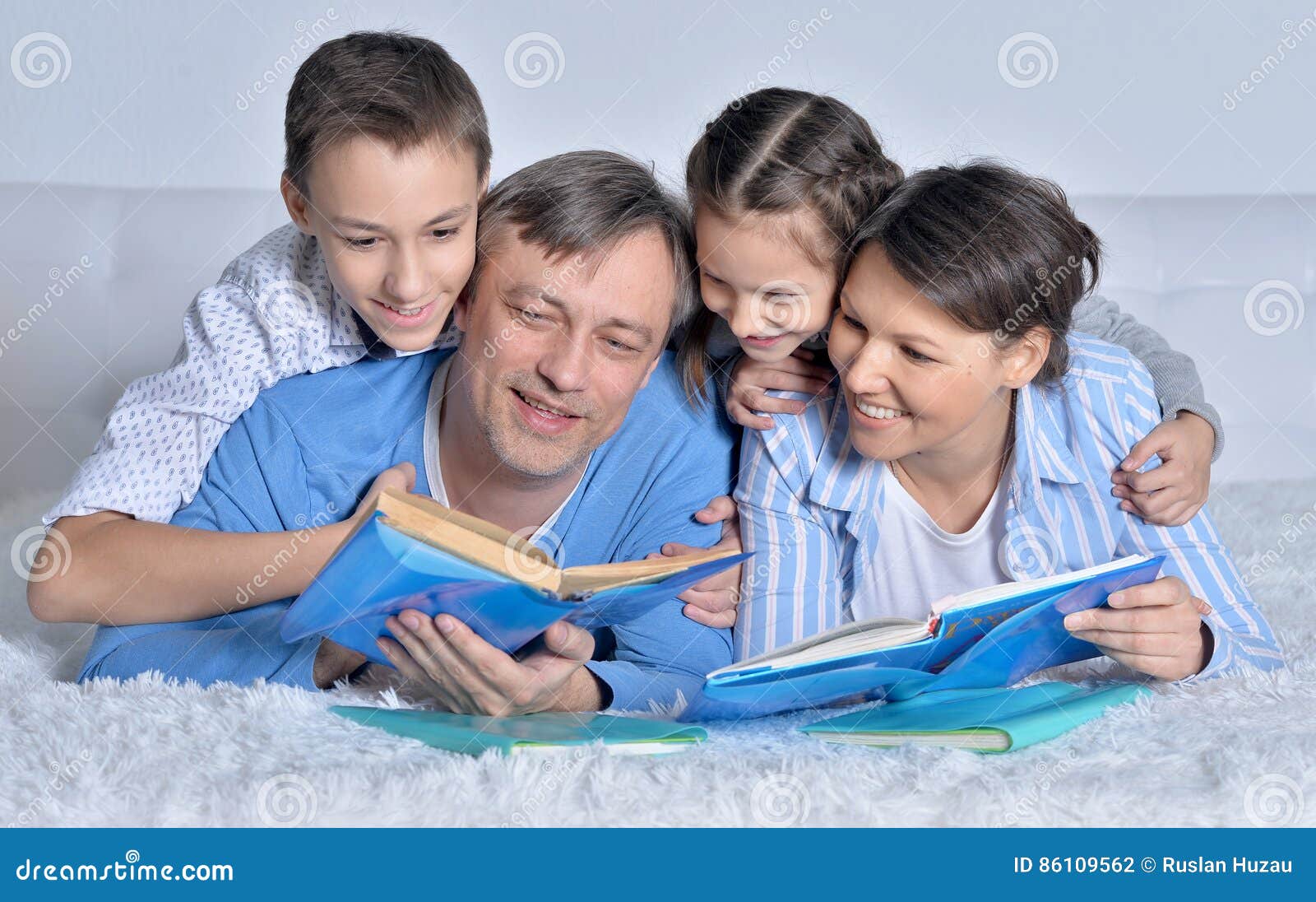 Family reading books stock photo. Image of parenthood - 86109562