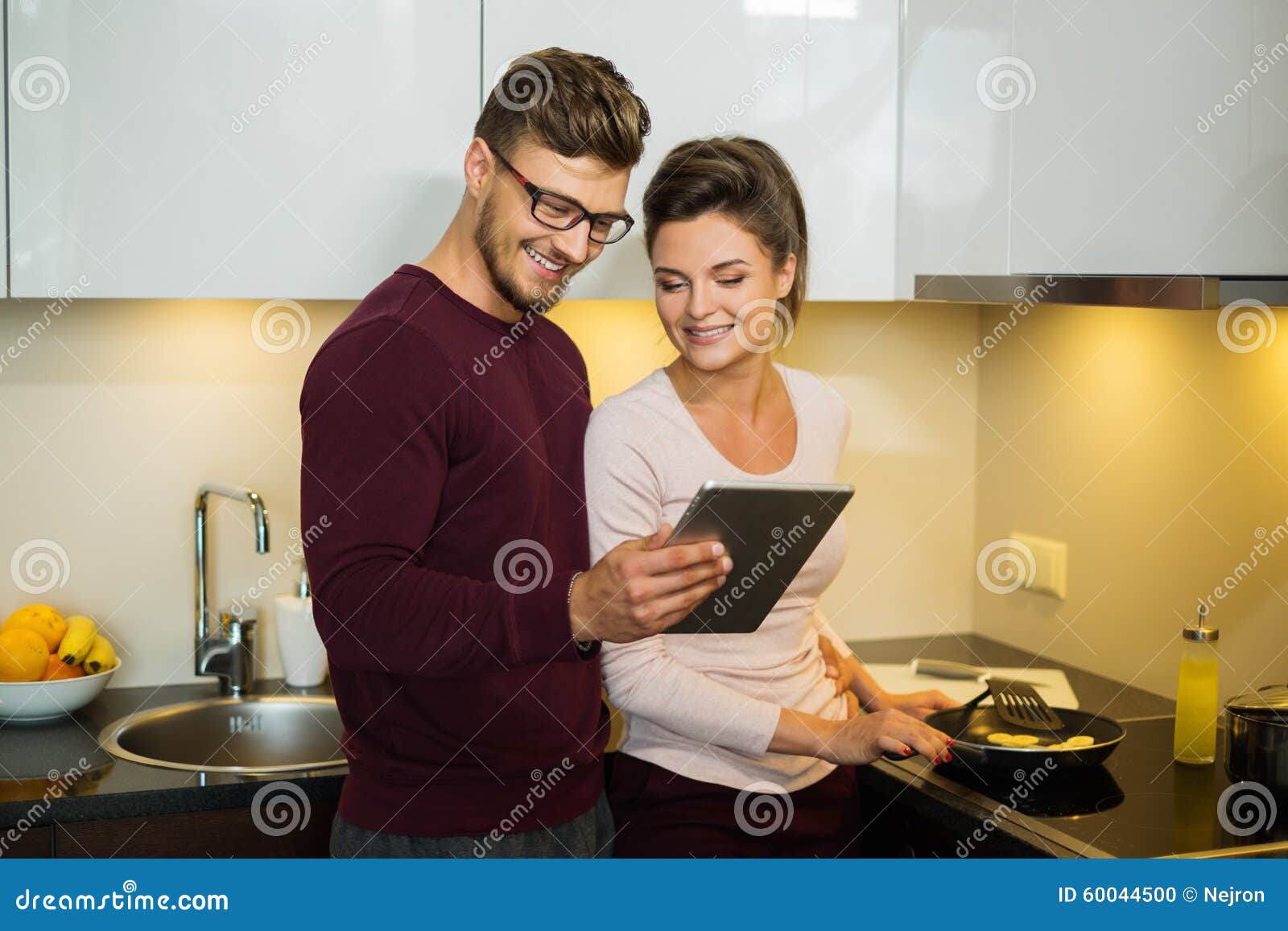 Family Reading Recipe in a Kitchen Stock Photo - Image of online ...