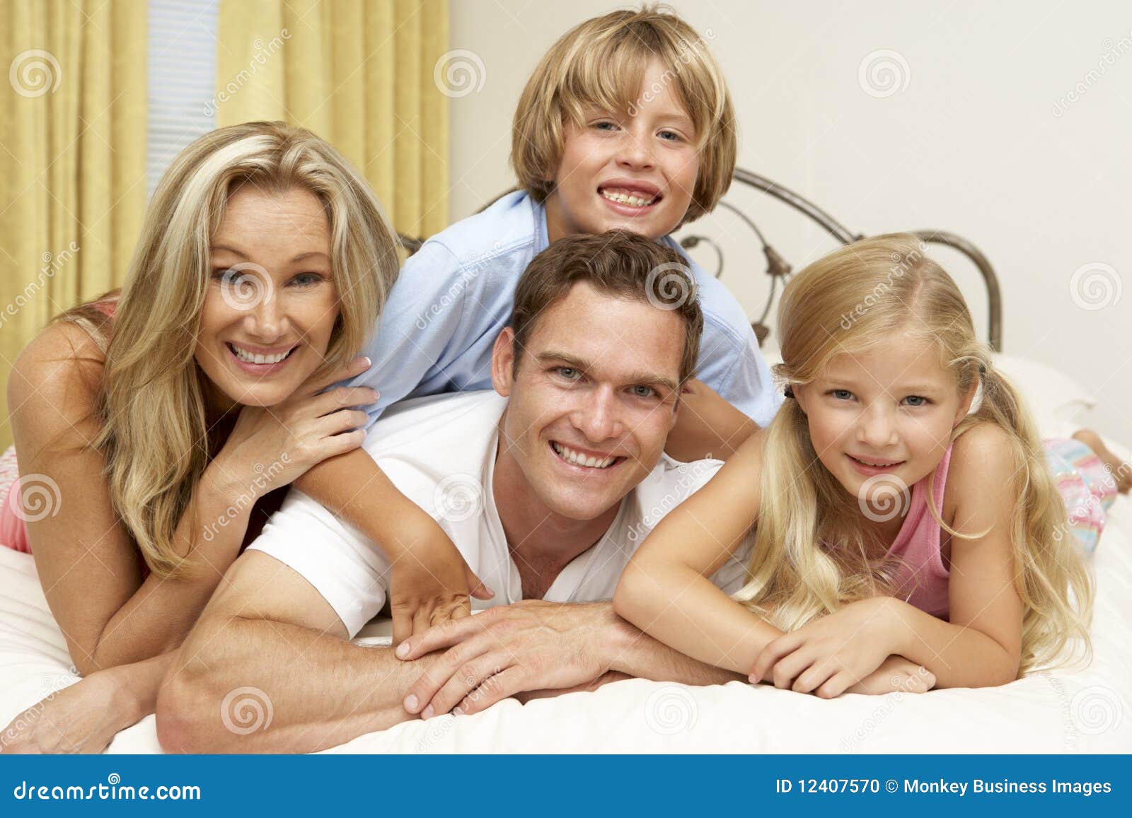 Family Relaxing on Bed at Home Stock Photo - Image of person, caucasian ...