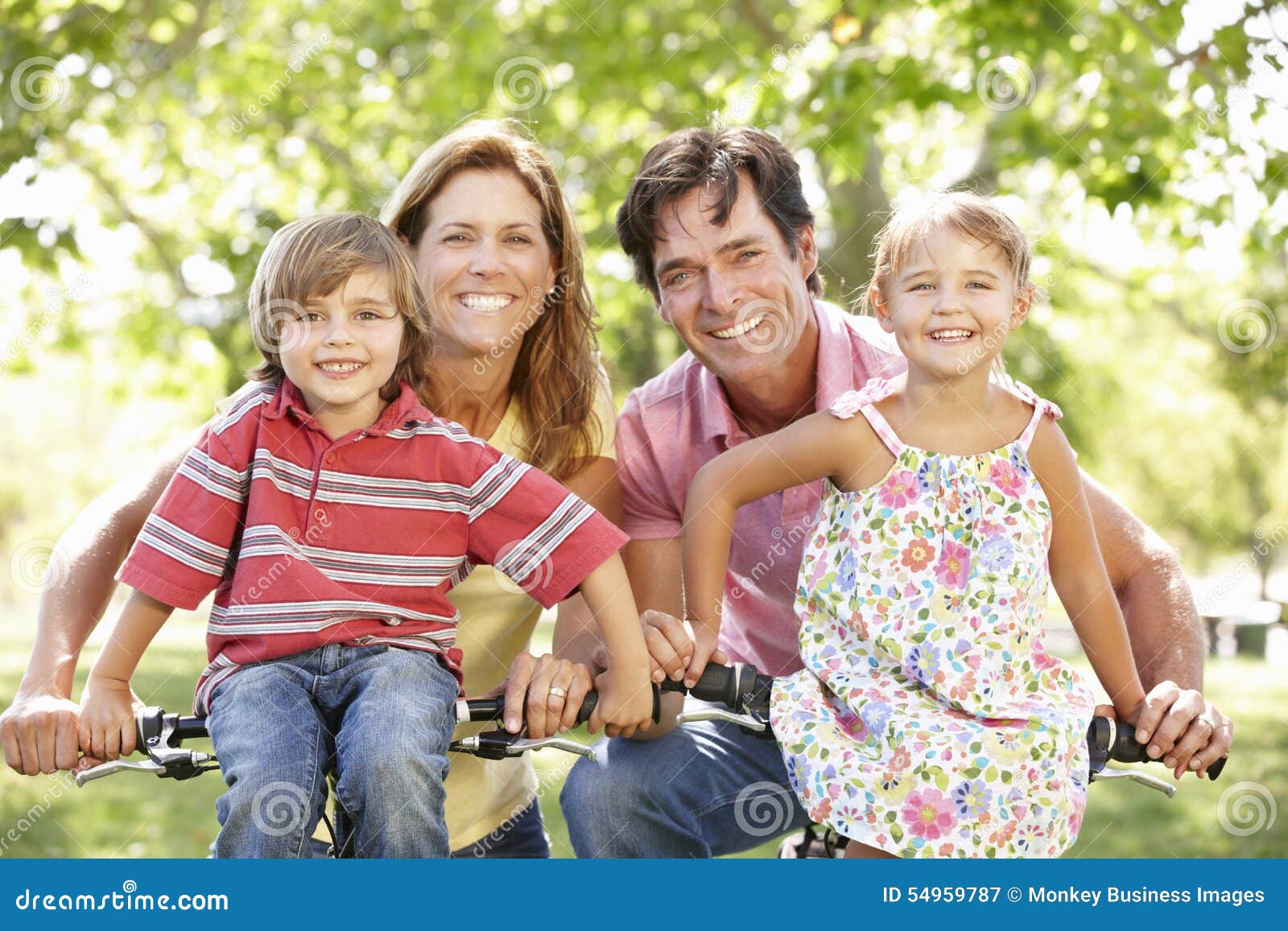 Family riding bikes stock image. Image of park, father - 54959787