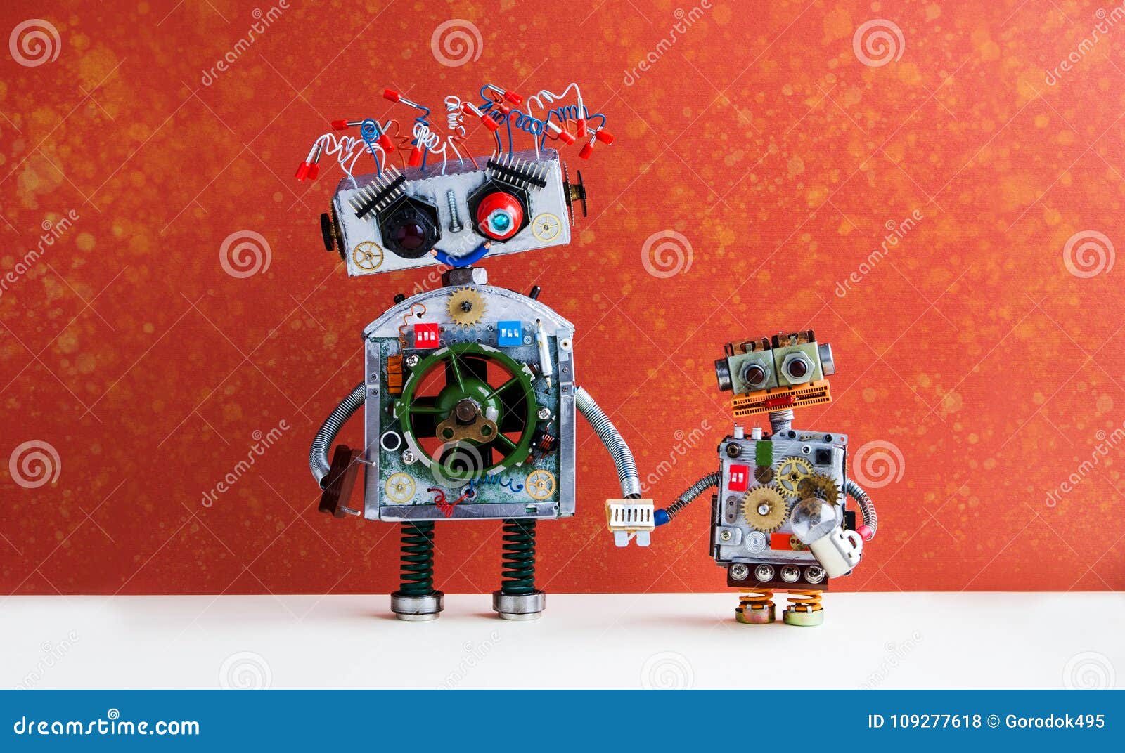Family Robots. Big Robot Mom Holds the Hand of a Small Child Robot ... Family Robots. Big Robot Mom Holds the Hand of a Small Child Robot ...