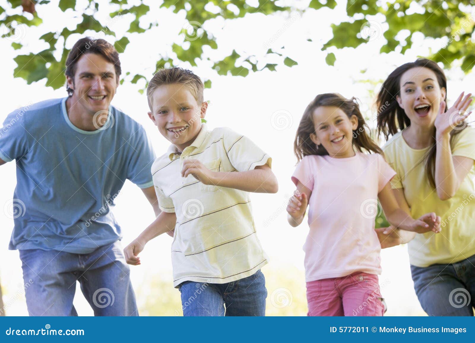 Family Running Outdoors Smiling Stock Image - Image of field, four: 5772011