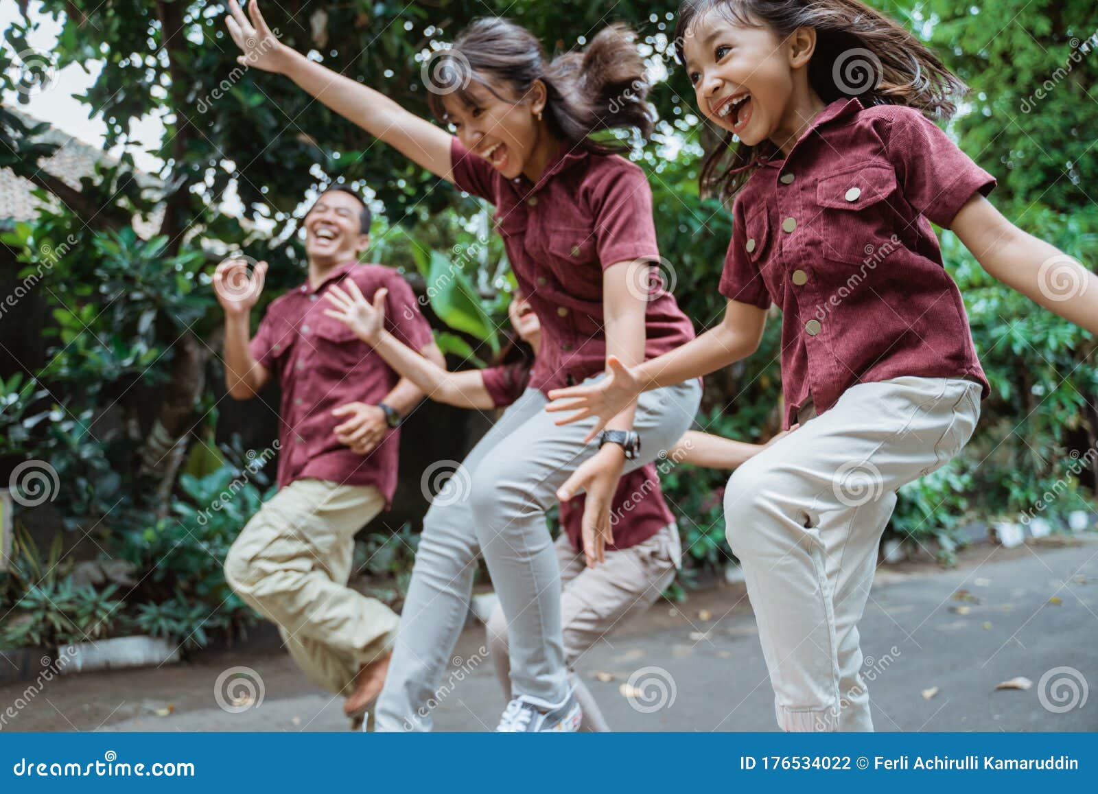 Family Running Outdoors Smiling and Enjoying the Weekend Stock Photo ...