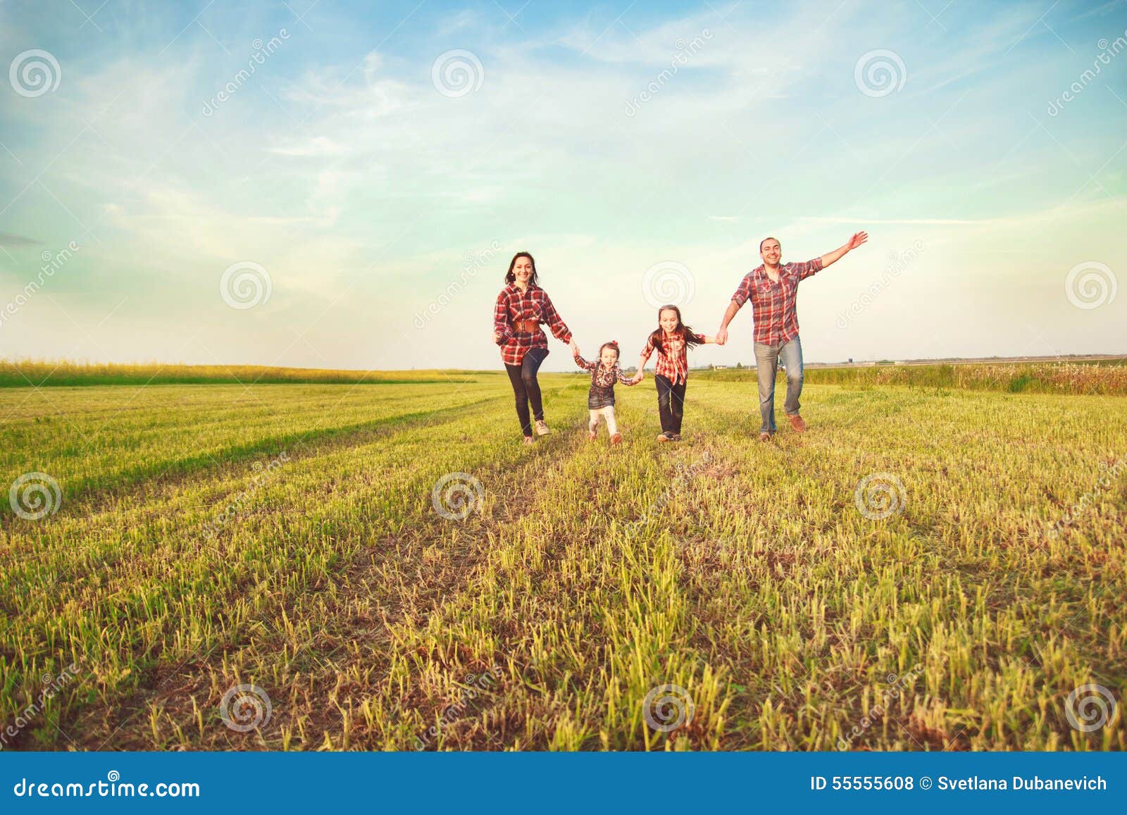 Family running together stock photo. Image of meadow - 55555608