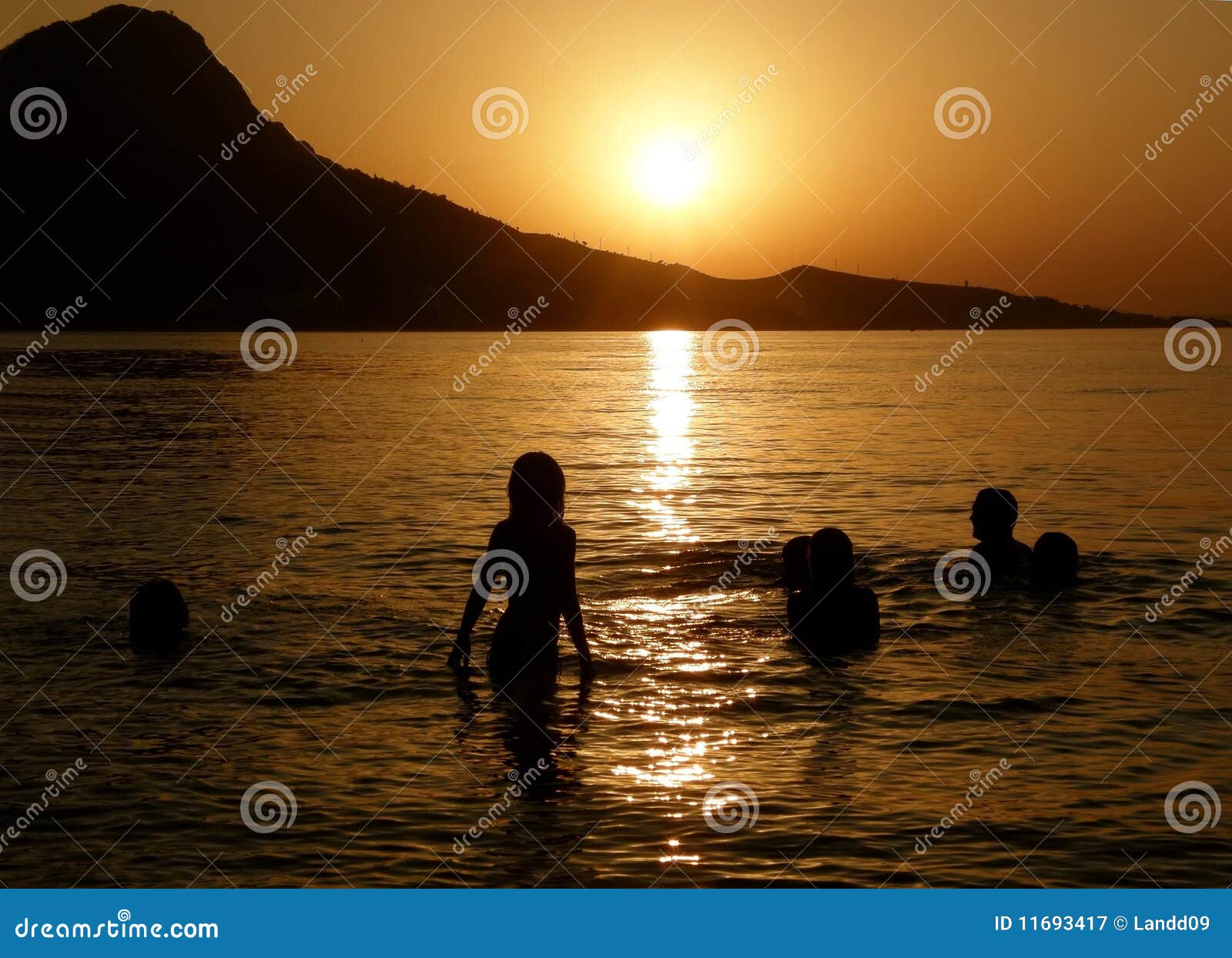 Family in sea at sunset stock image. Image of bathing - 11693417