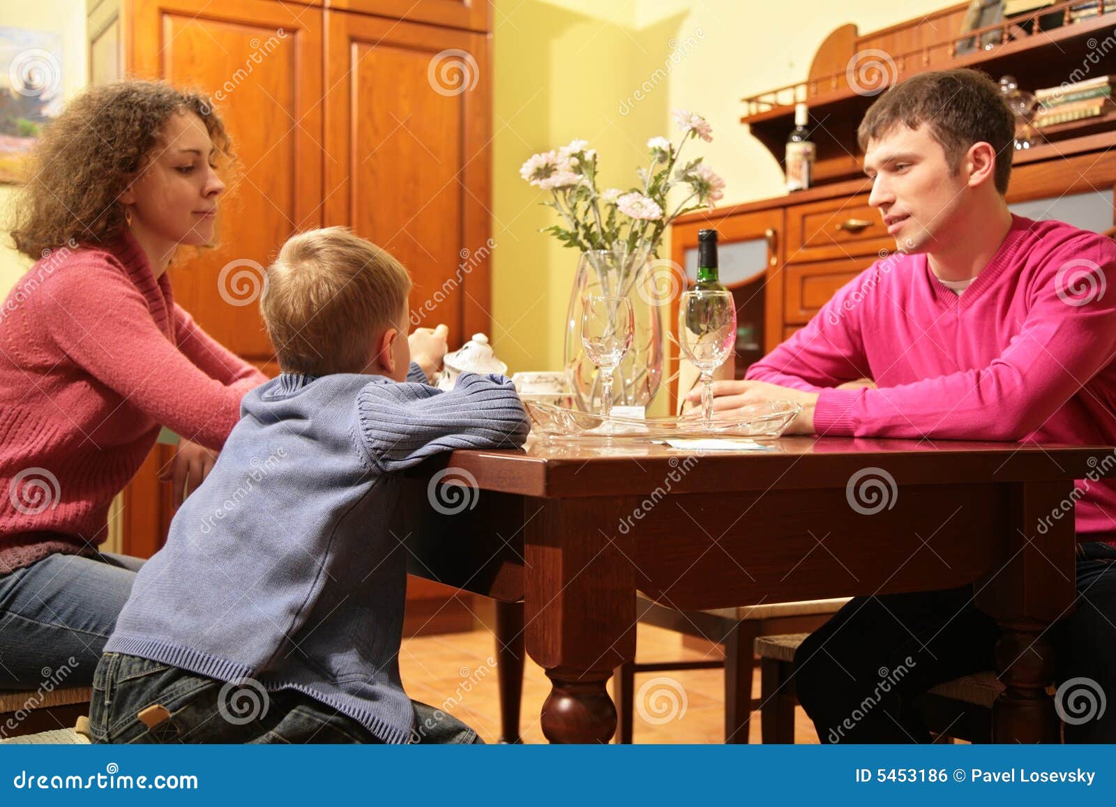 Family seats behind table stock photo. Image of girl, happy - 5453186