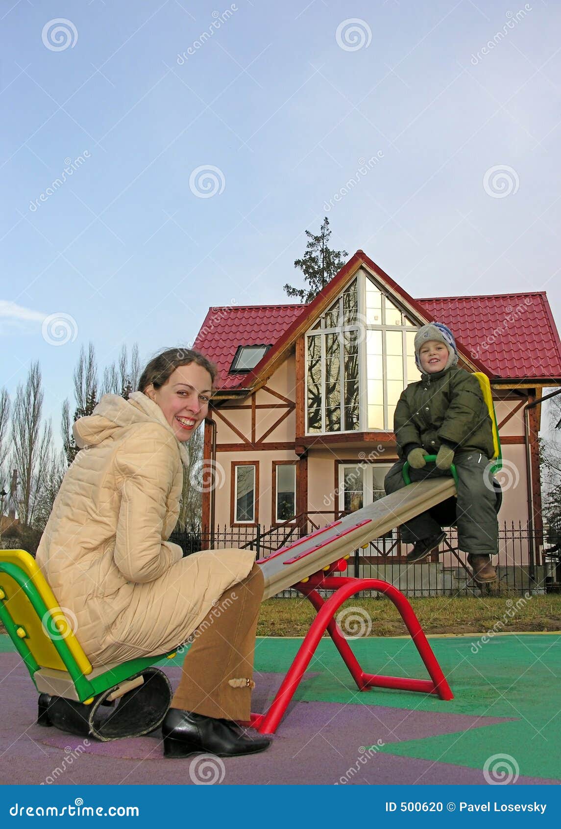 Family on seesaw and home stock photo. Image of landscape - 500620