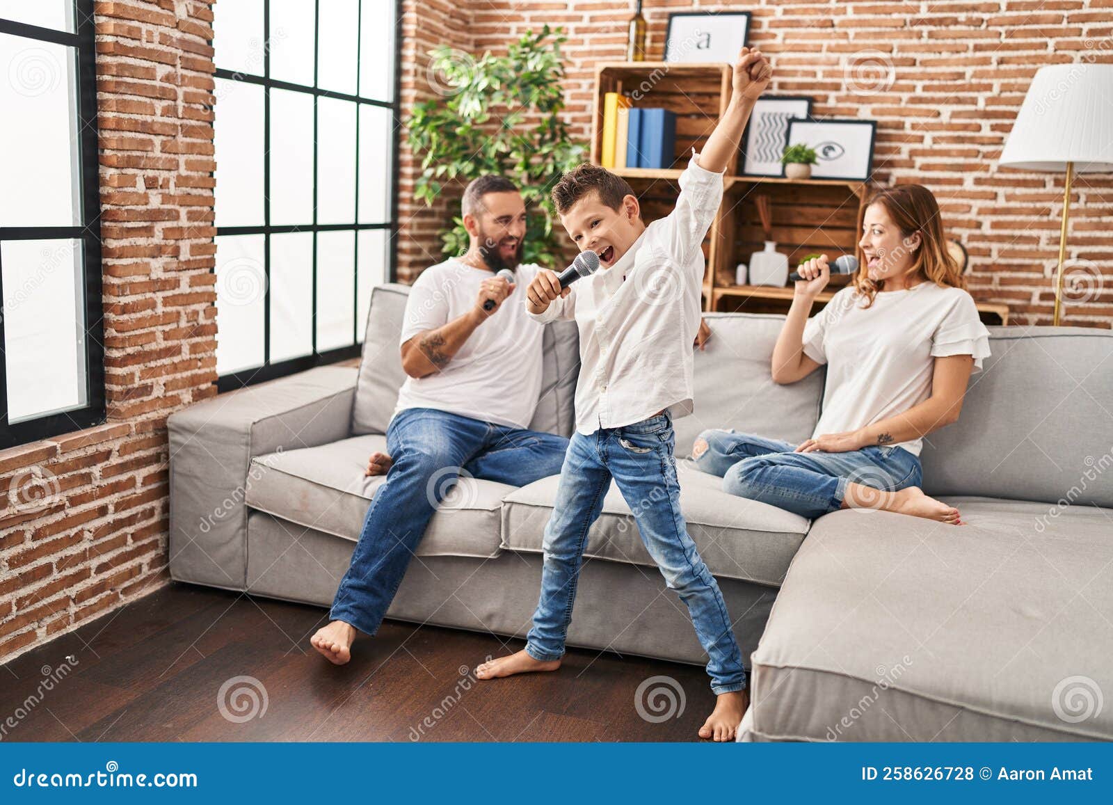 Family Singing Song Using Microphone at Home Stock Photo - Image of ...