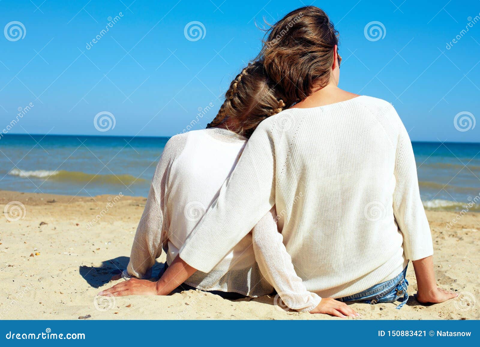 Family Sit Hugging on the Sea and Look at the Water. Time Stock Image ...