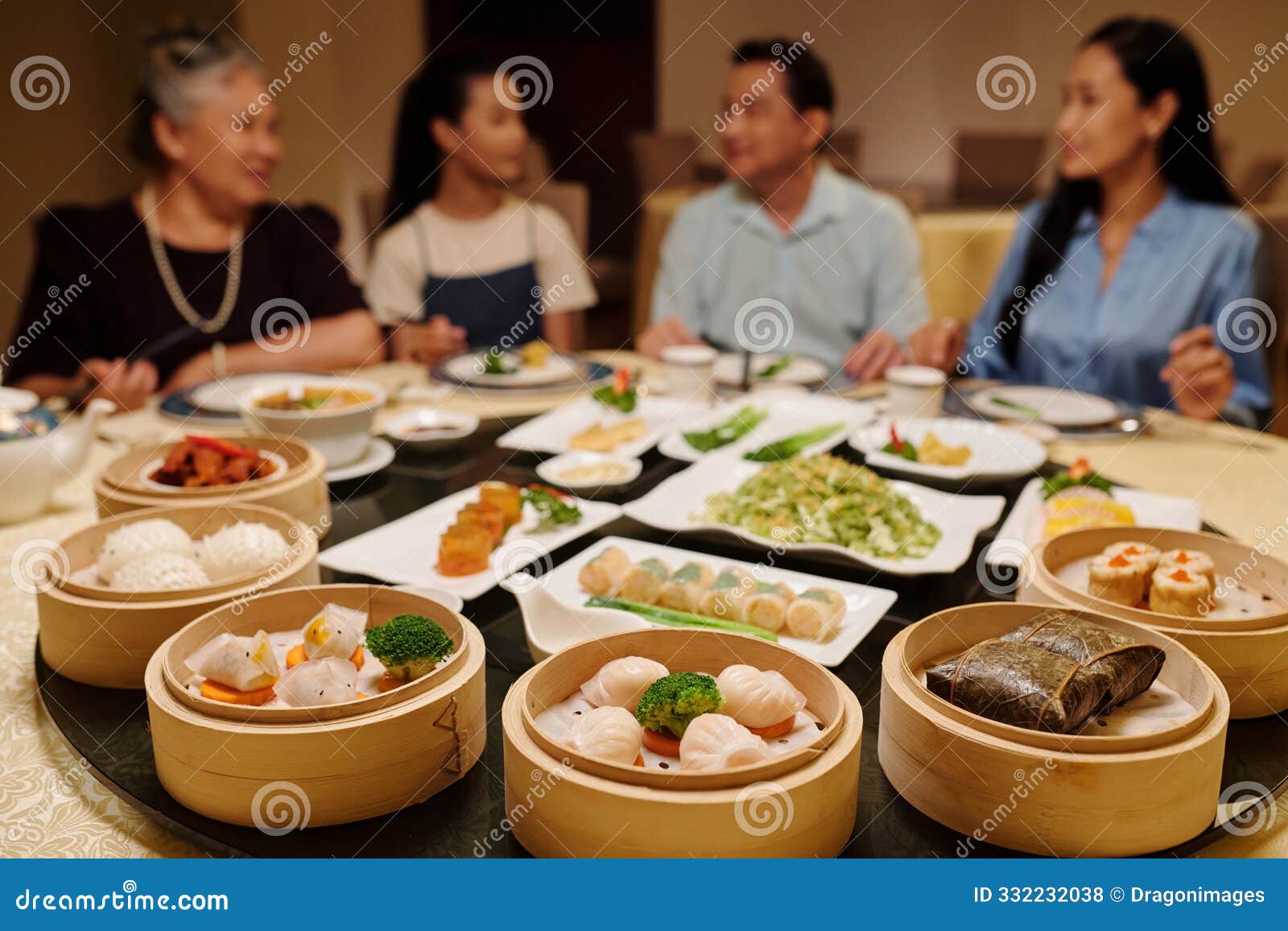Family Sitting at Dining Table with Various Dishes Stock Photo - Image ...