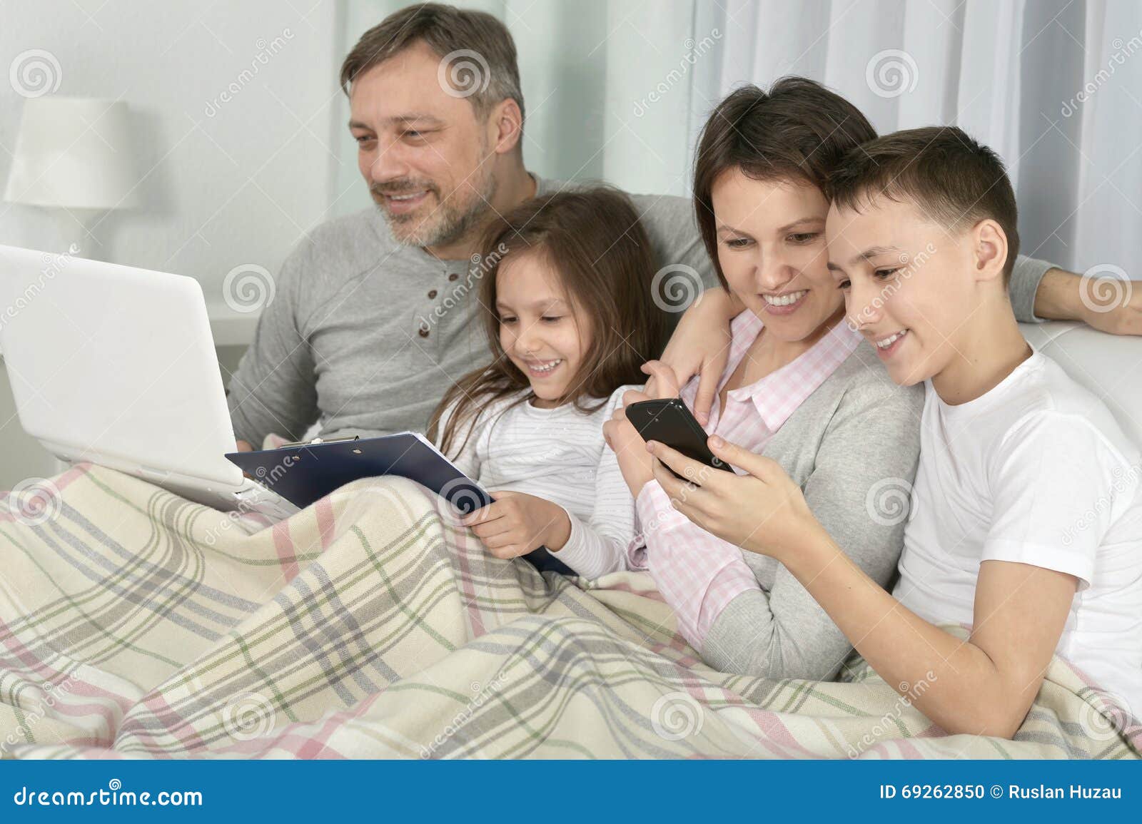 Family Sitting with Electronic Gadgets Stock Photo - Image of phone ...