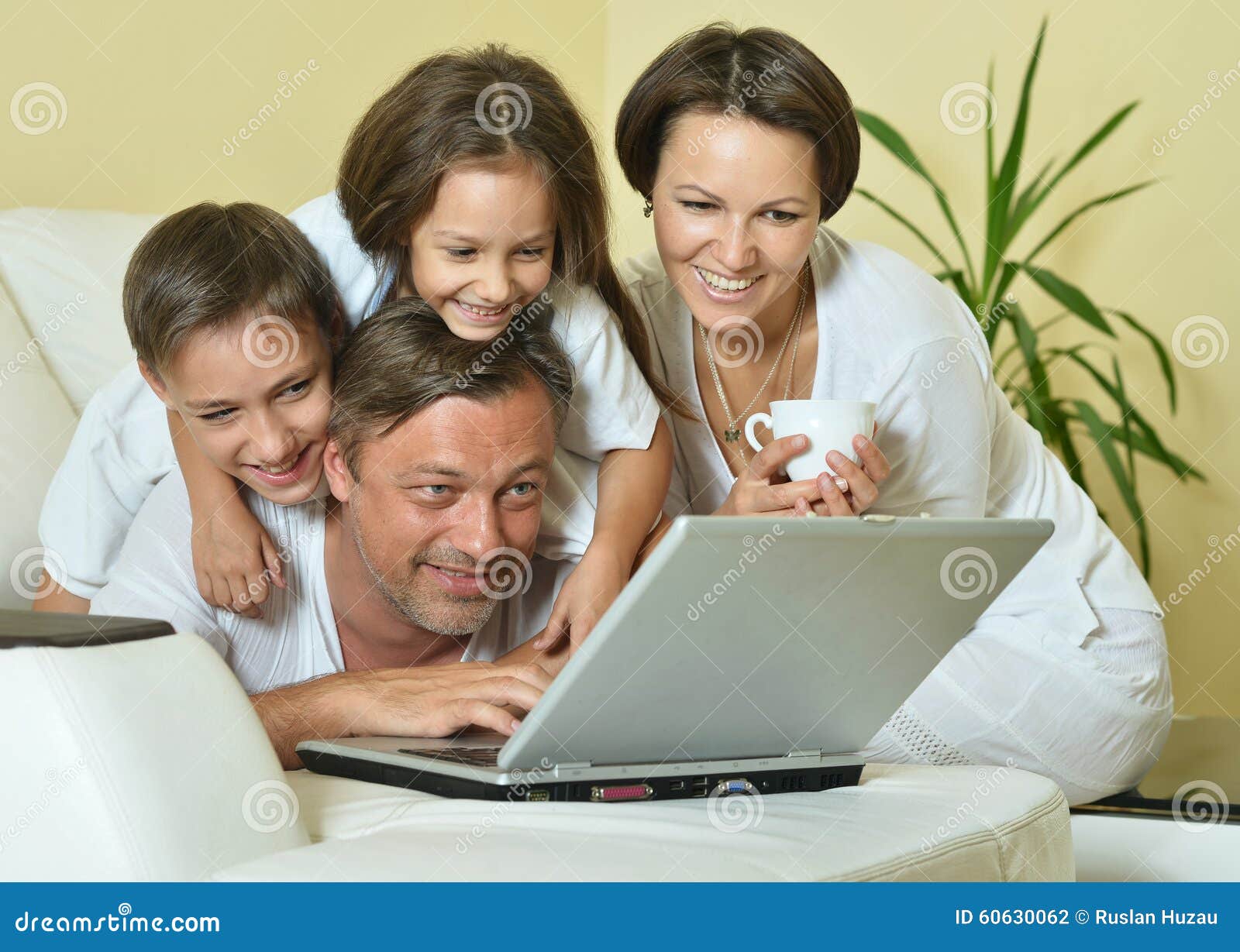 Family sitting with laptop stock photo. Image of wireless - 60630062