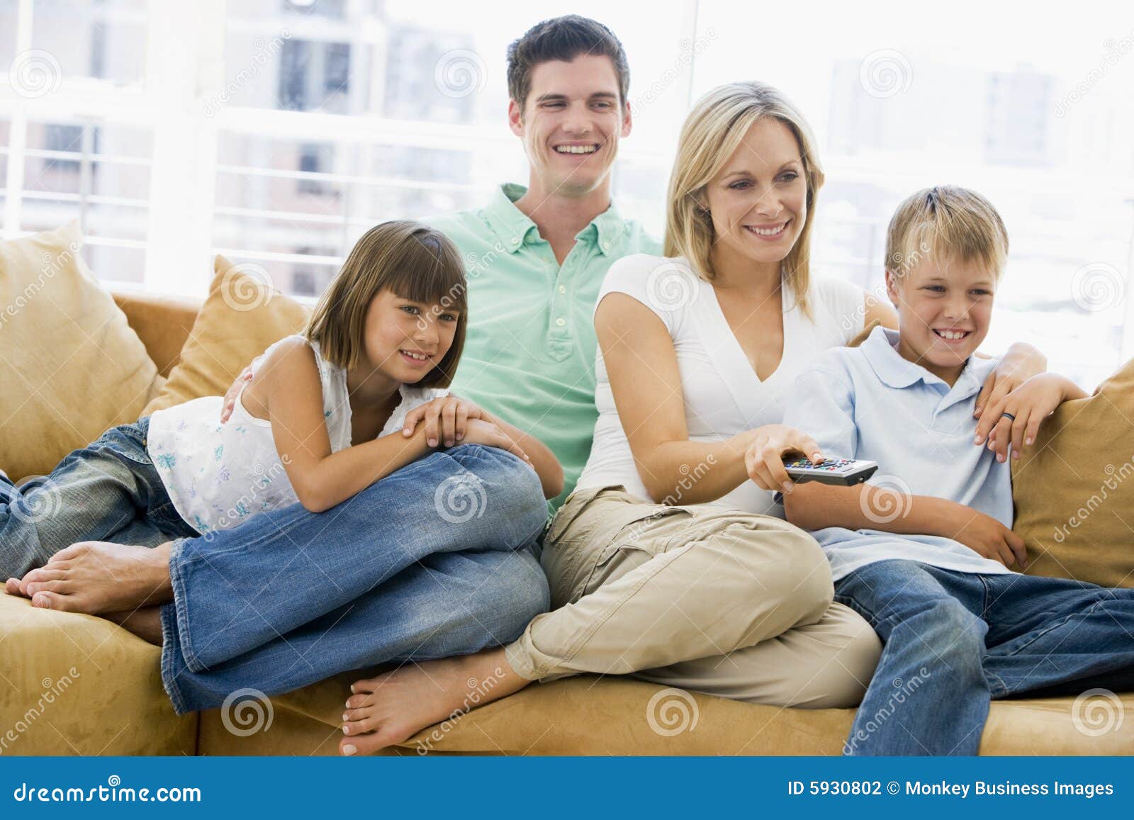 Family Sitting in Living Room with Remote Control Stock Photo - Image ...
