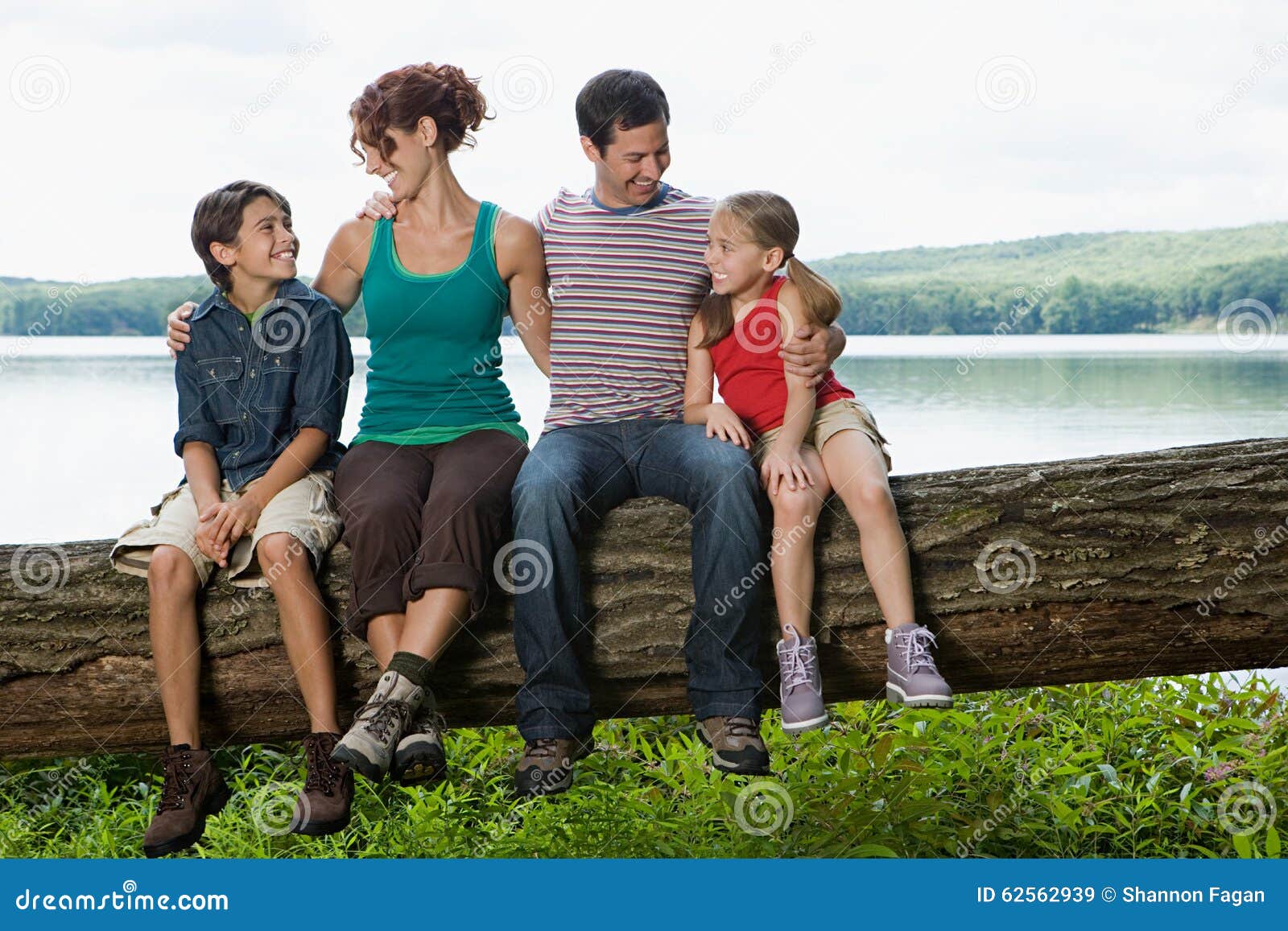 Family sitting on a log stock image. Image of girl, childhood - 62562939